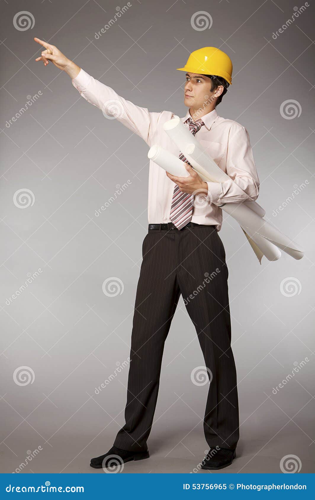 Young Caucasian Engineer with Plans Pointing Finger Away Stock Image ...