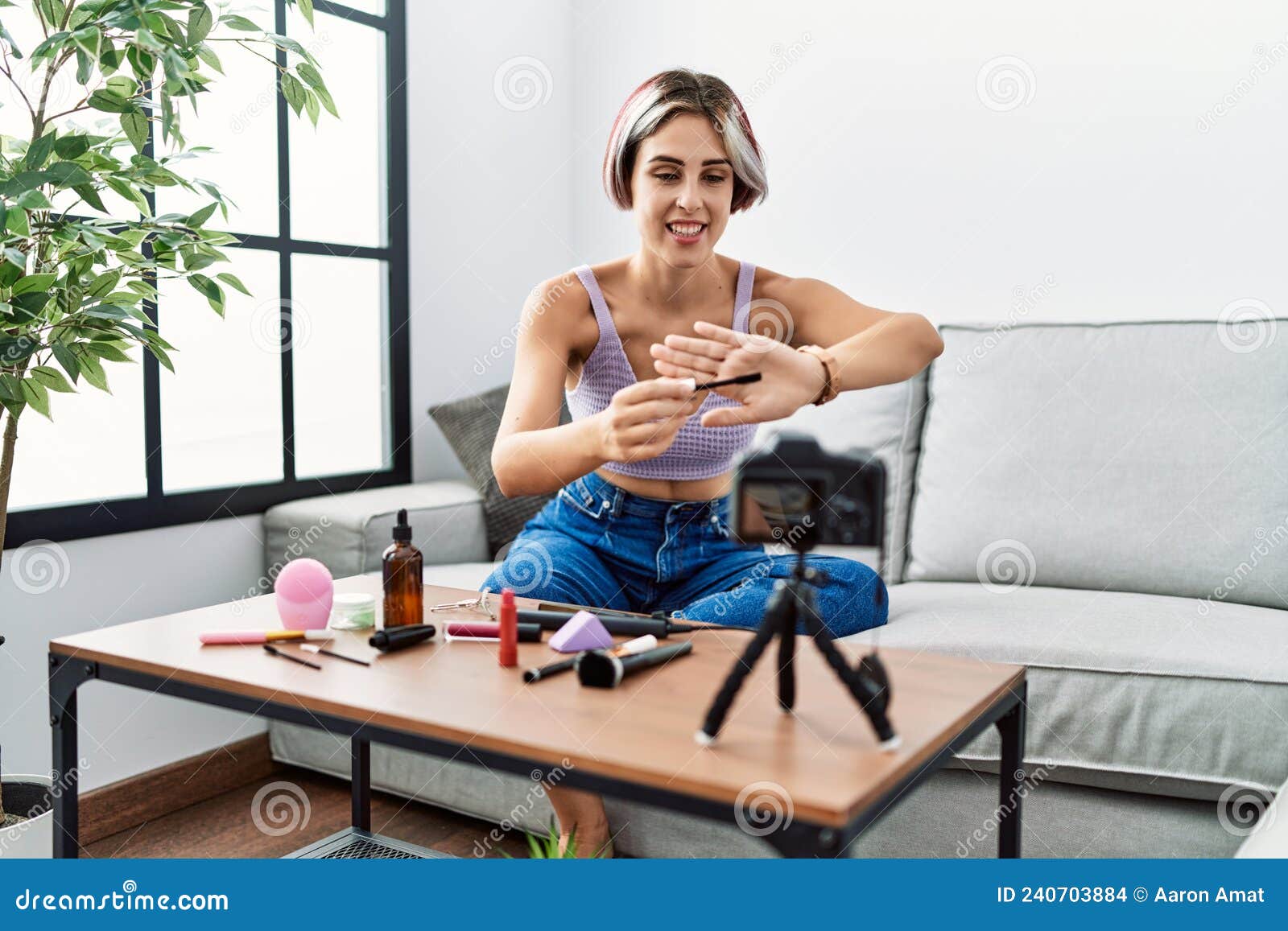Young Caucasian Girl Making Makeup Tutorial Sitting on the Sofa at Home ...