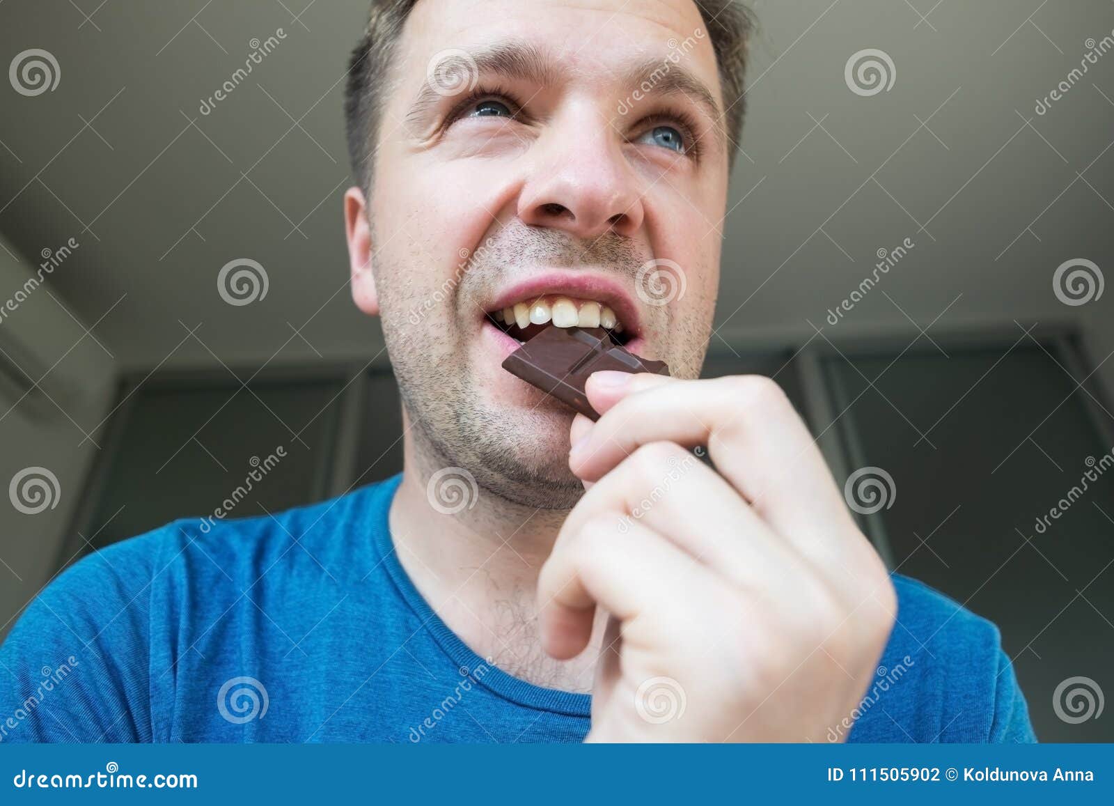 Young Caucasian Guy Eating a Chocolate Alone Stock Photo - Image of ...