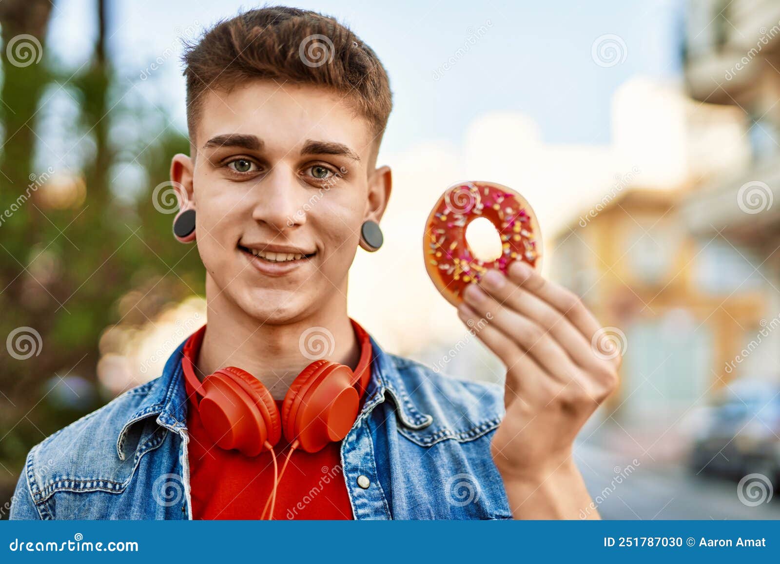 Young Caucasian Guy Smiling Holding Doughnut at the City Stock Photo ...