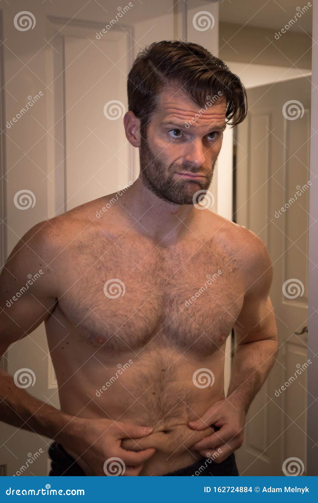 A Young Caucasian Man Dismayed with His Belly Fat. Stock Photo - Image ...