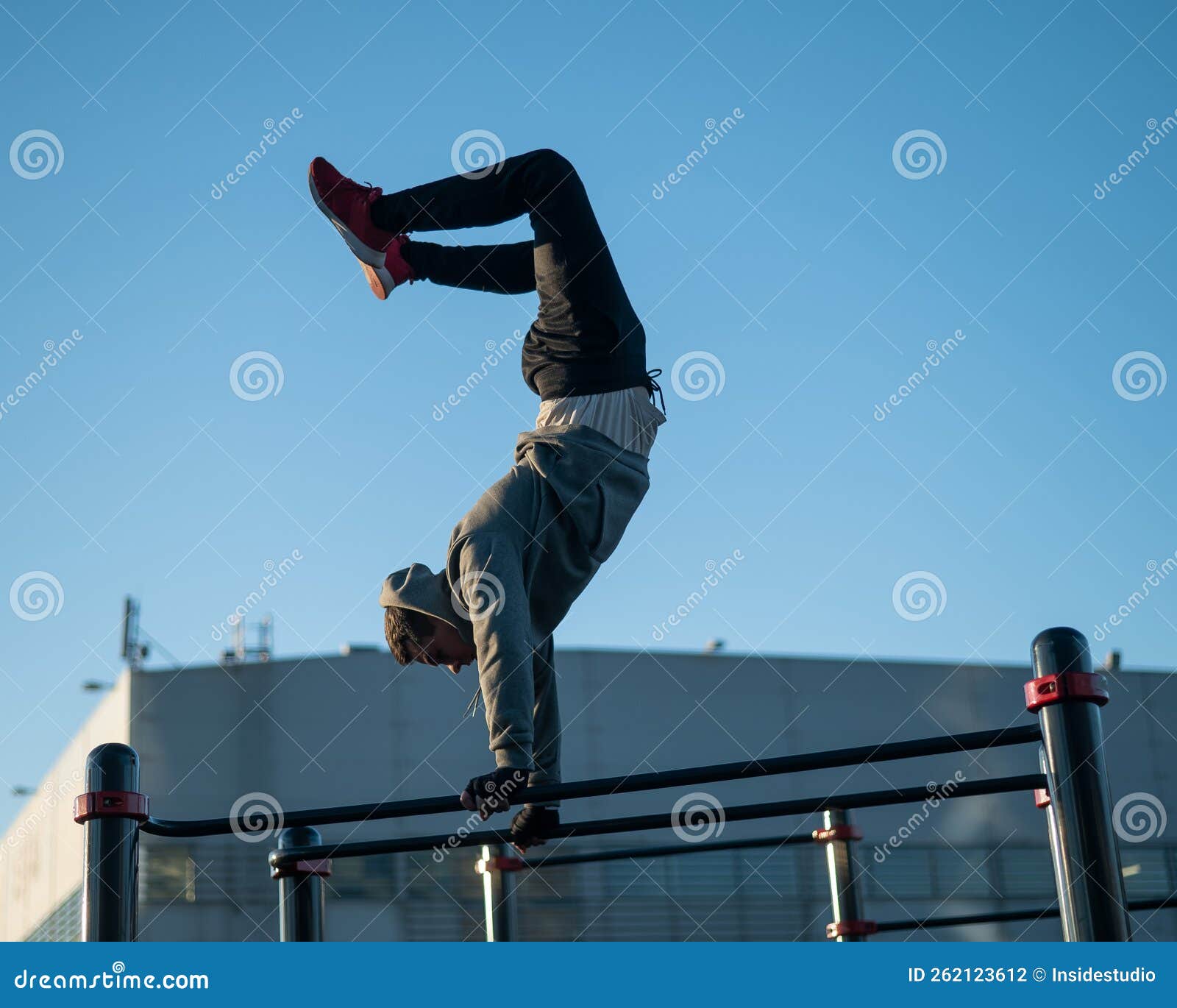 Young Caucasian Man Doing Parallel Bars Exercise Outdoors. Stock Photo ...