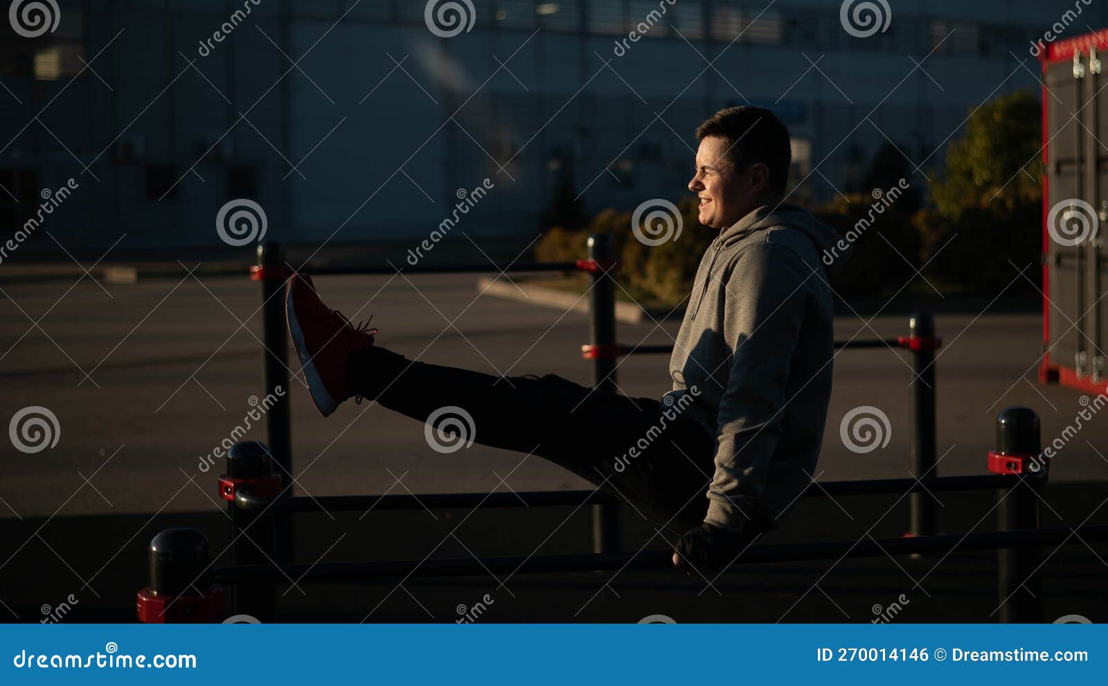 Young Caucasian Man Doing Parallel Bars Exercise Outdoors. Stock Photo ...