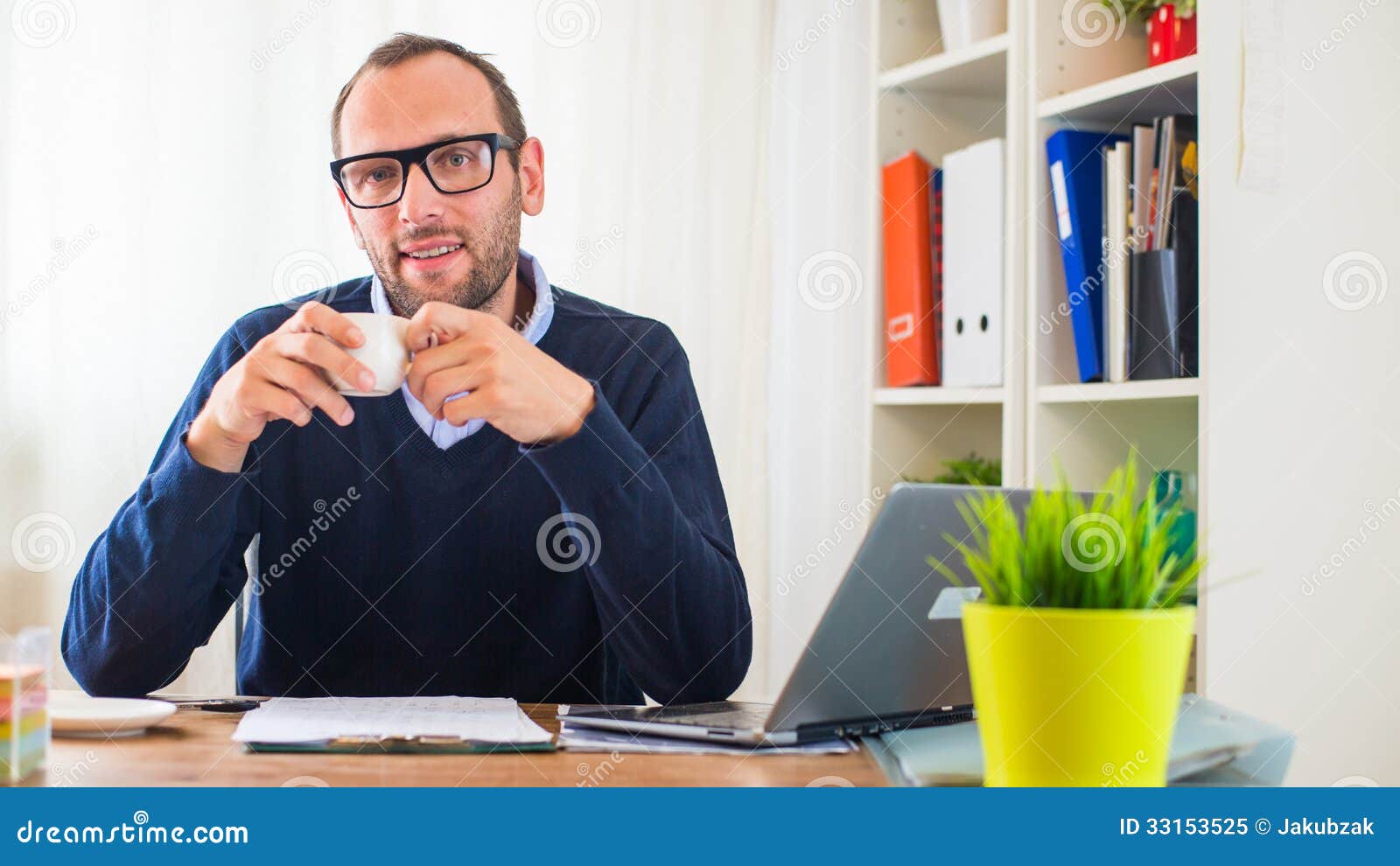 A Young Caucasian Man Drinking Coffee in His Office. Stock Image ...