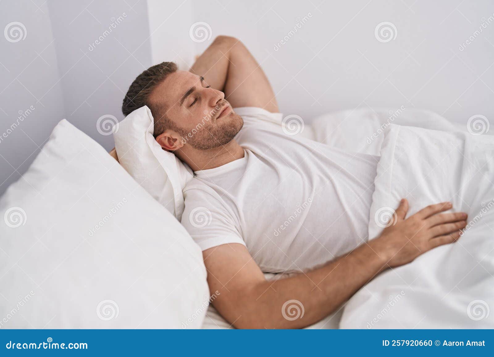 Young Caucasian Man Lying on Bed Sleeping at Bedroom Stock Photo ...