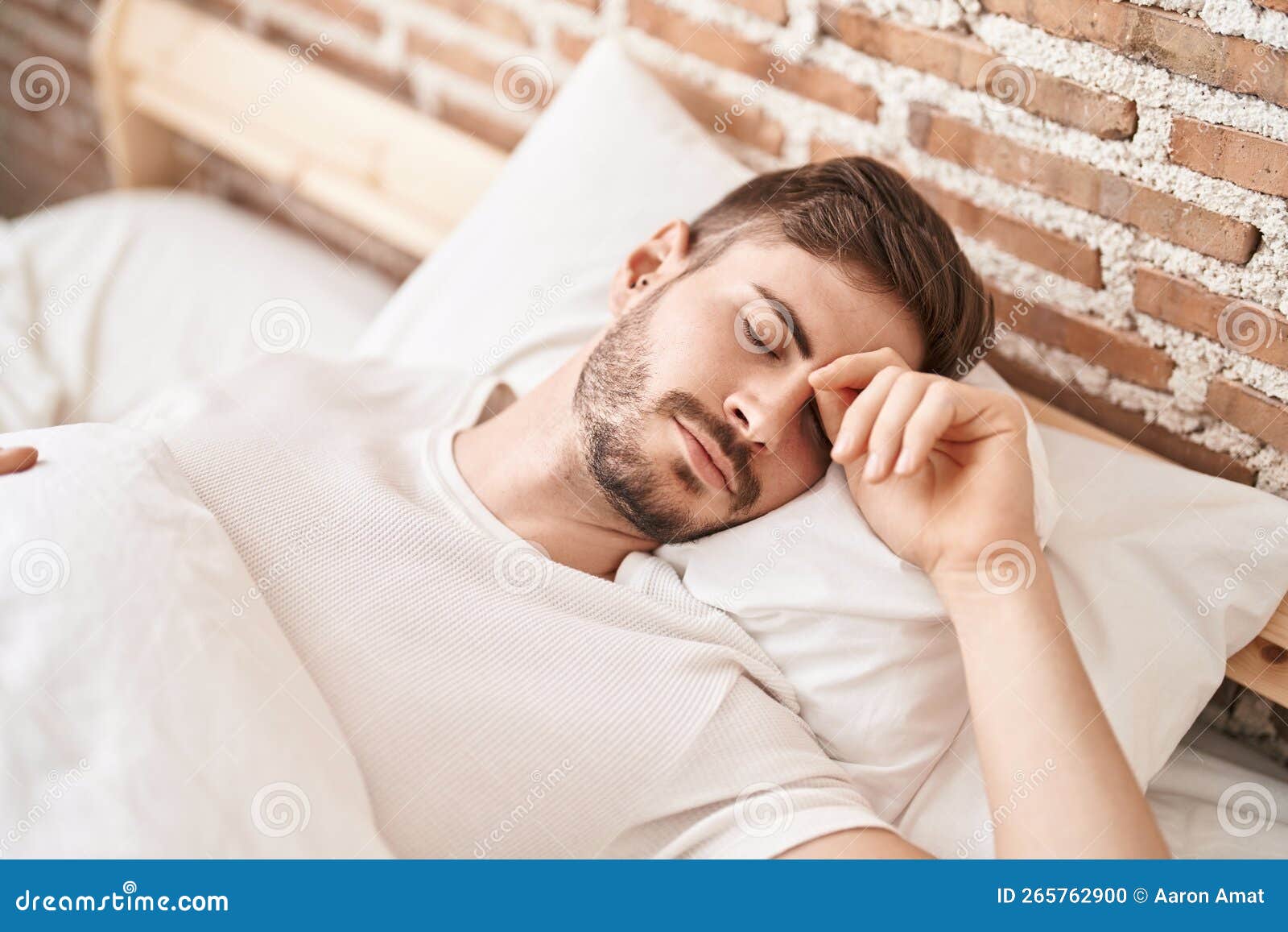 Young Caucasian Man Lying on Bed Sleeping at Bedroom Stock Photo ...