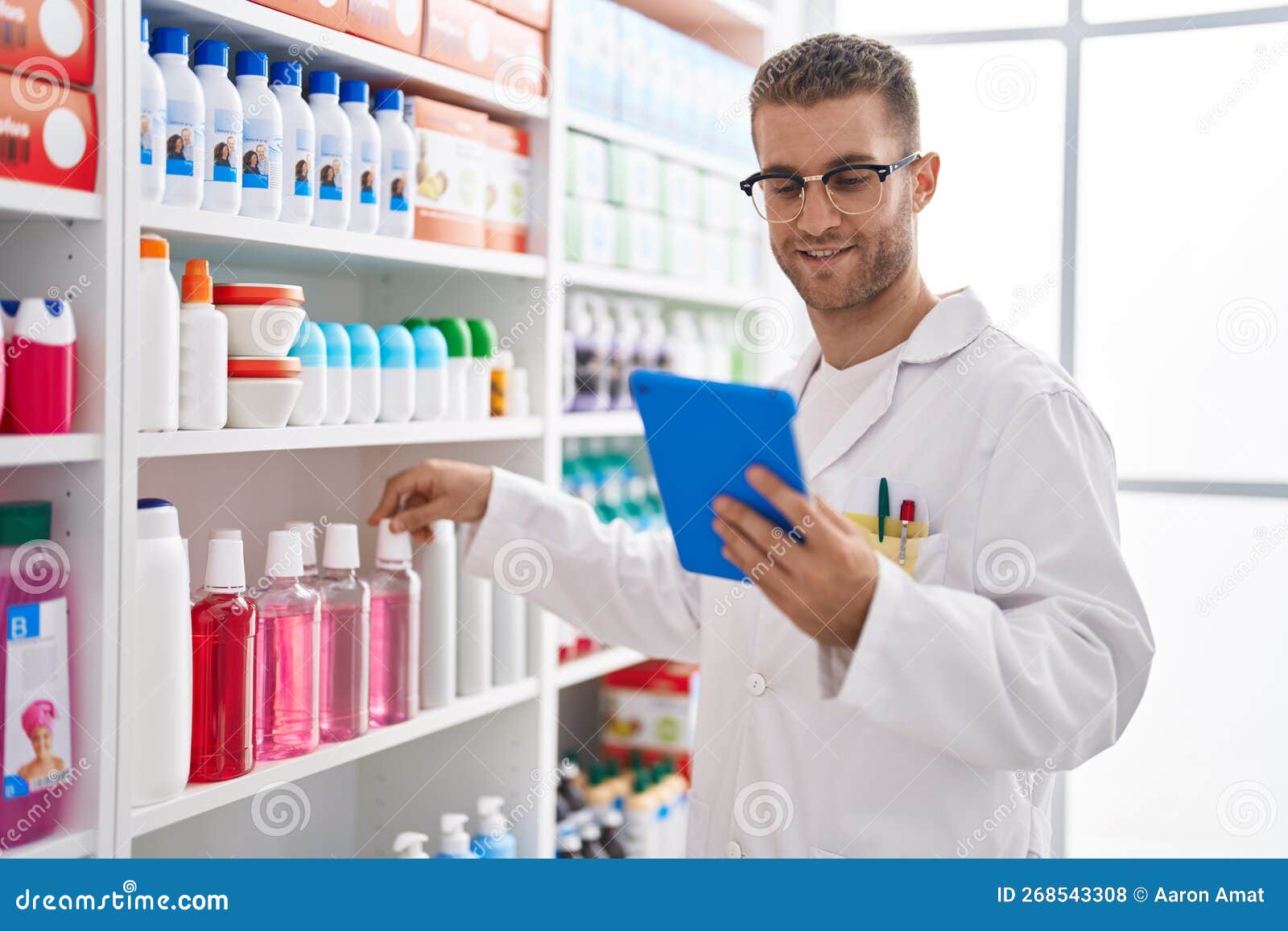 Young Caucasian Man Pharmacist Using Touchpad Working at Pharmacy Stock ...