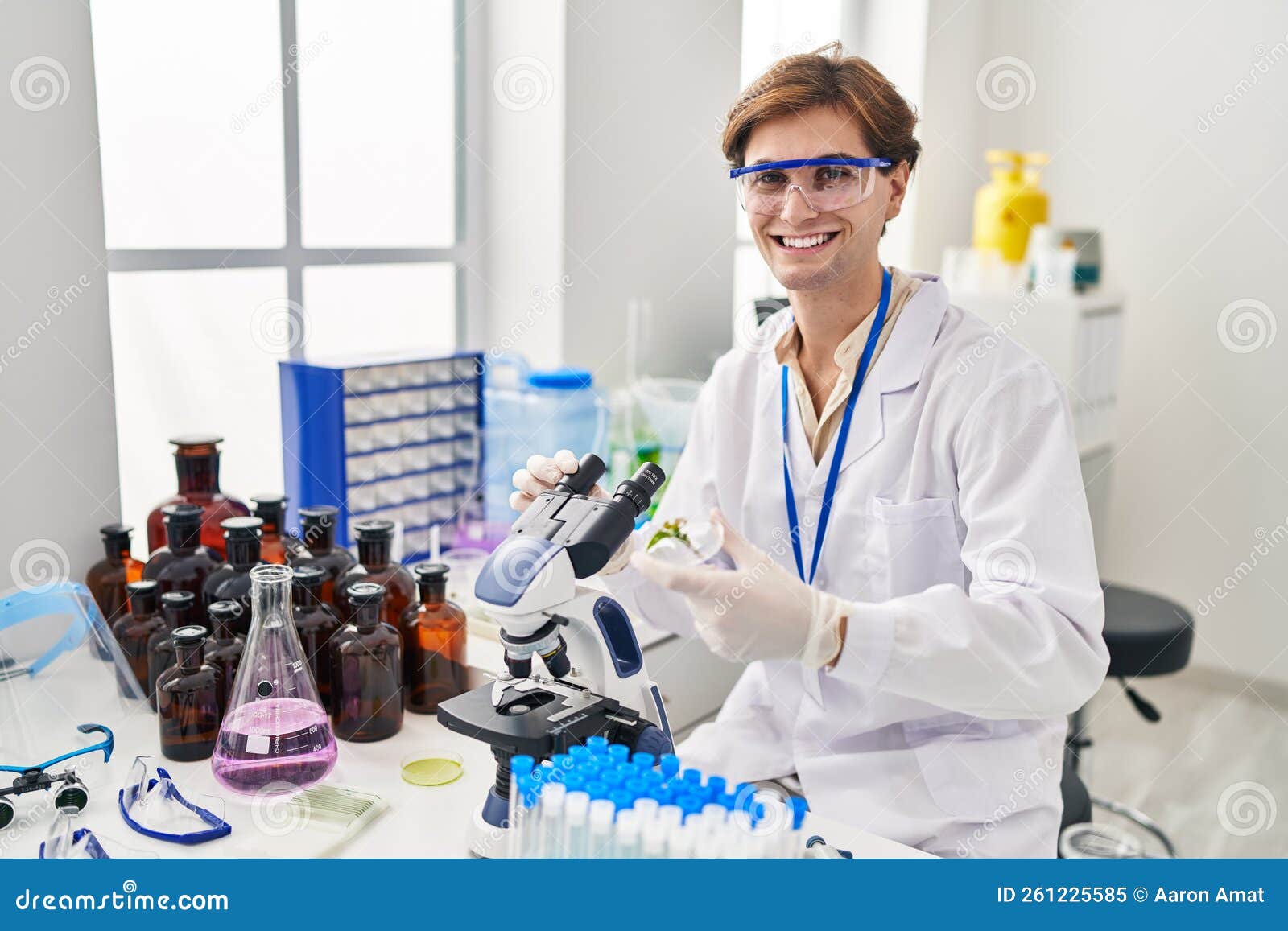 Young Caucasian Man Scientist Using Microscope Holding Plant Sample at ...