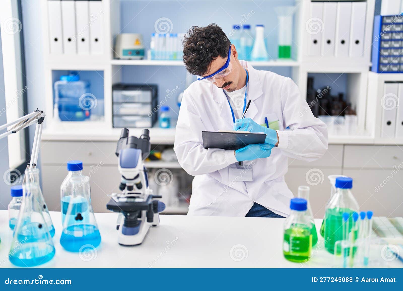 Young Caucasian Man Scientist Writing Report Working at Laboratory ...