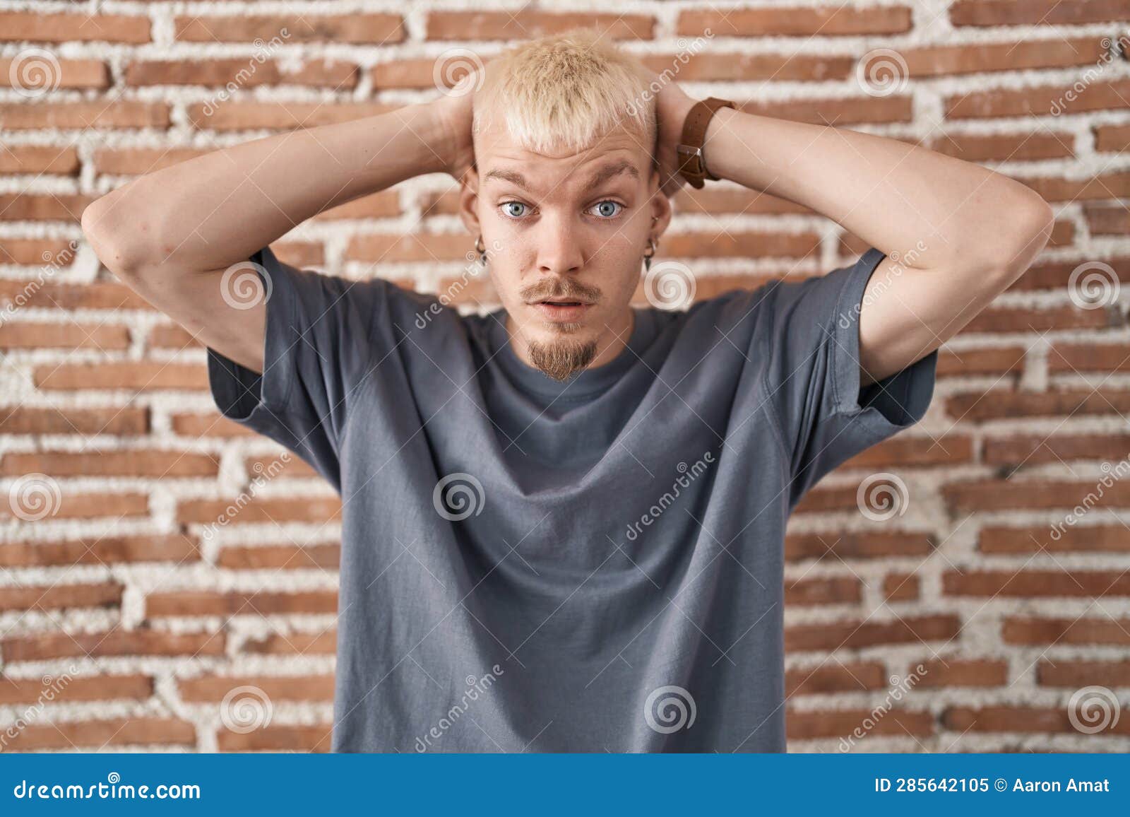 Young Caucasian Man Standing Over Bricks Wall Crazy and Scared with ...