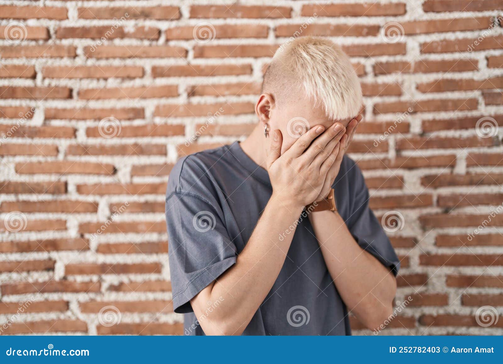 Young Caucasian Man Standing Over Bricks Wall with Sad Expression ...