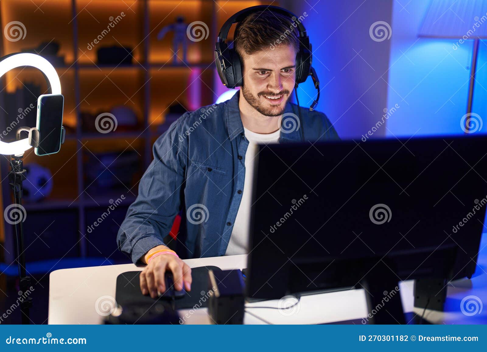 Young Caucasian Man Streamer Playing Video Game Using Computer at ...