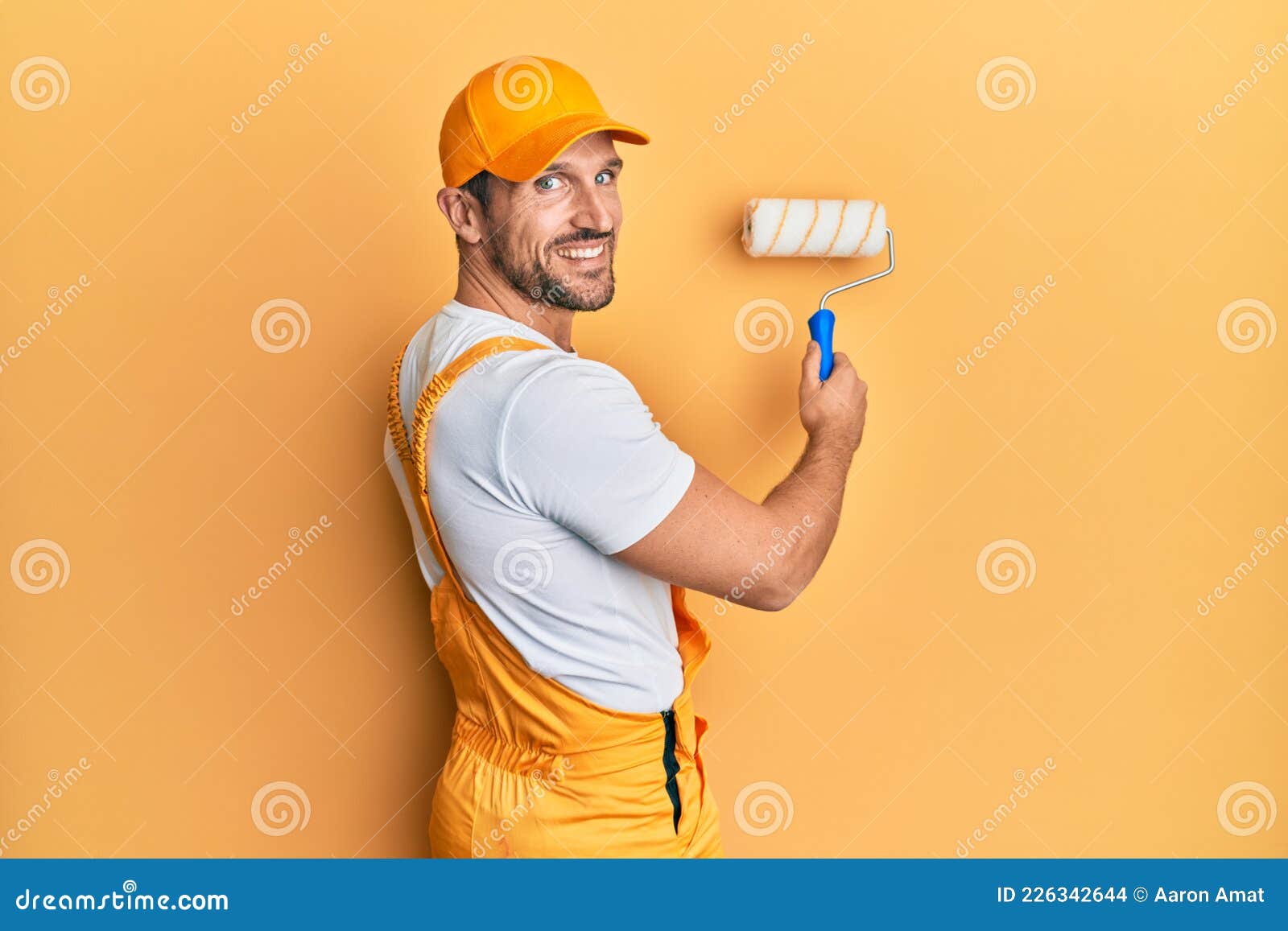 Young Caucasian Painter Smiling Happy Painting Wall Using Roller Stock ...