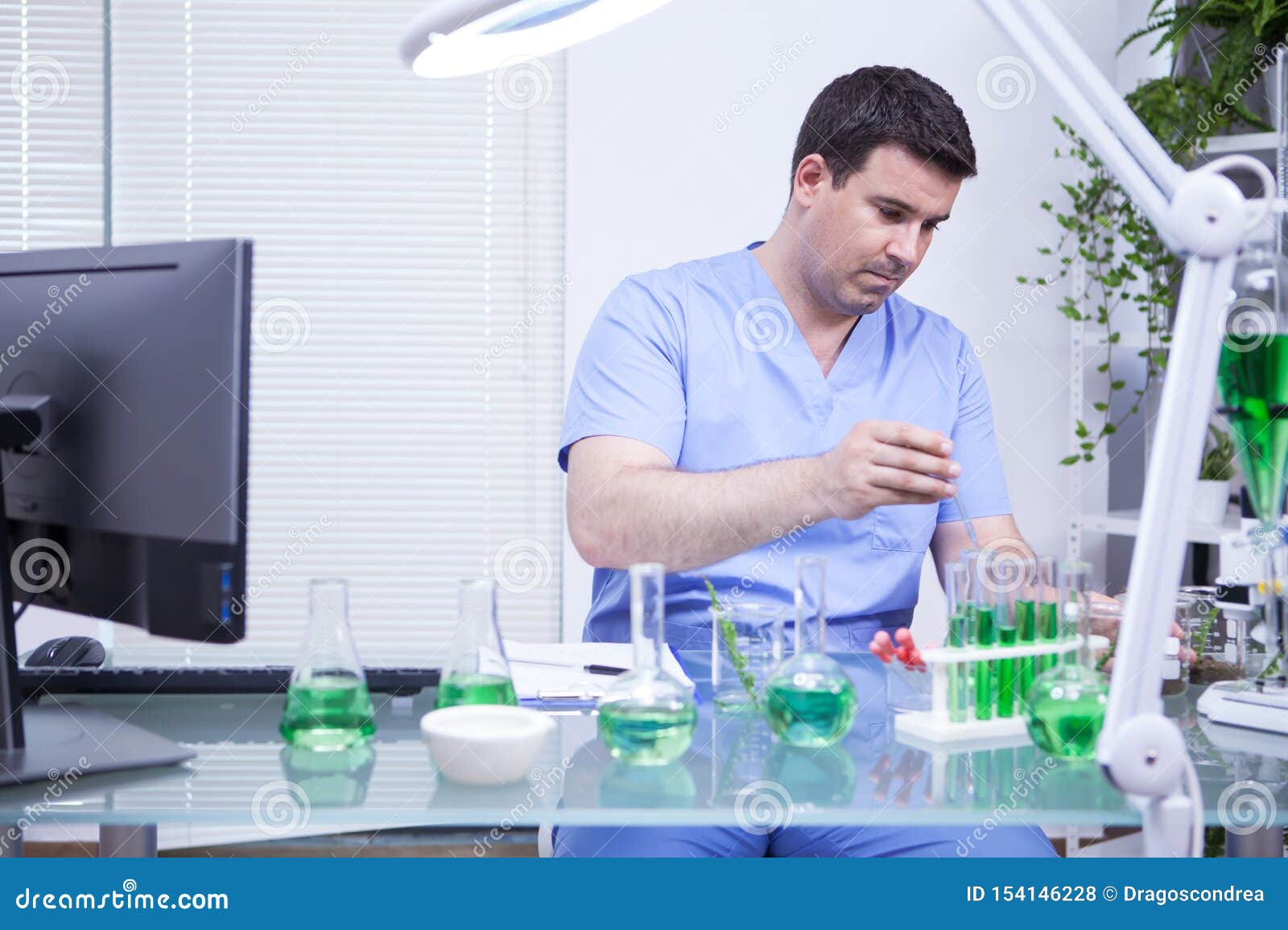 Young Caucasian Scientist Man Taking a Sample of Solution from a Test ...
