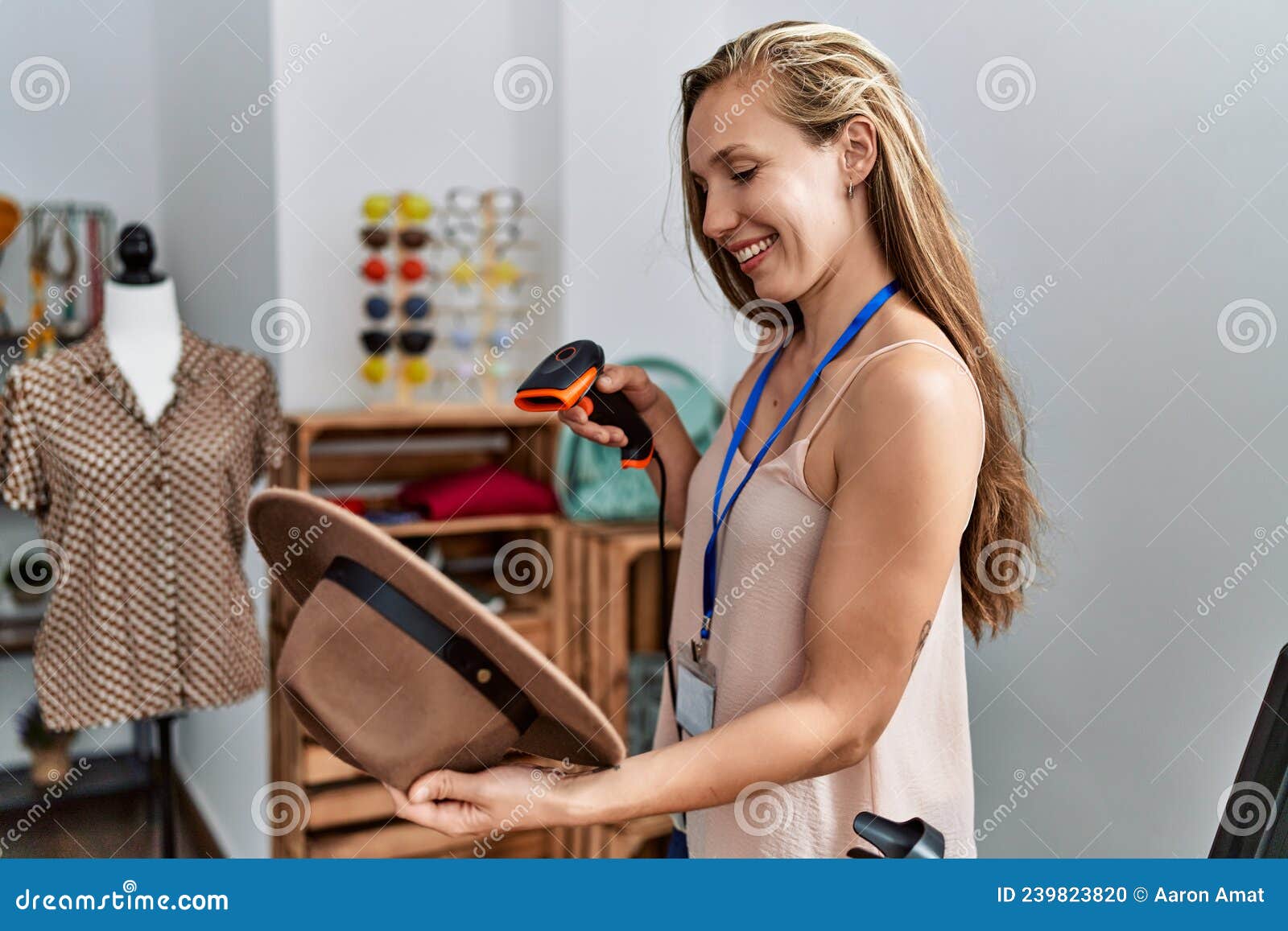 Young Caucasian Woman Shopkeeper Scanning Hat Using Barcode Reader at ...
