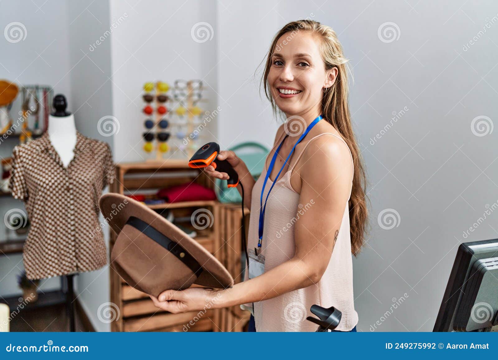 Young Caucasian Woman Shopkeeper Scanning Hat Using Barcode Reader at ...