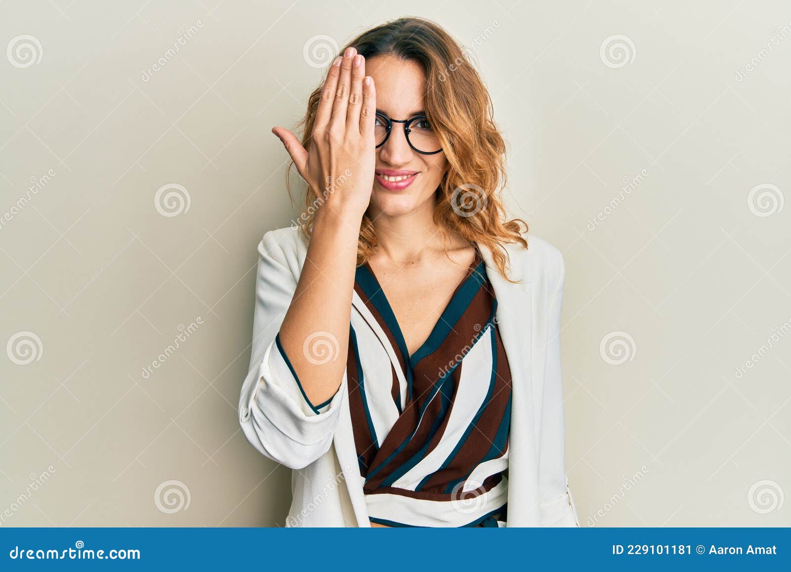 Young Caucasian Woman Wearing Business Style and Glasses Covering One ... Young Caucasian Woman Wearing Business Style and Glasses Covering One ...