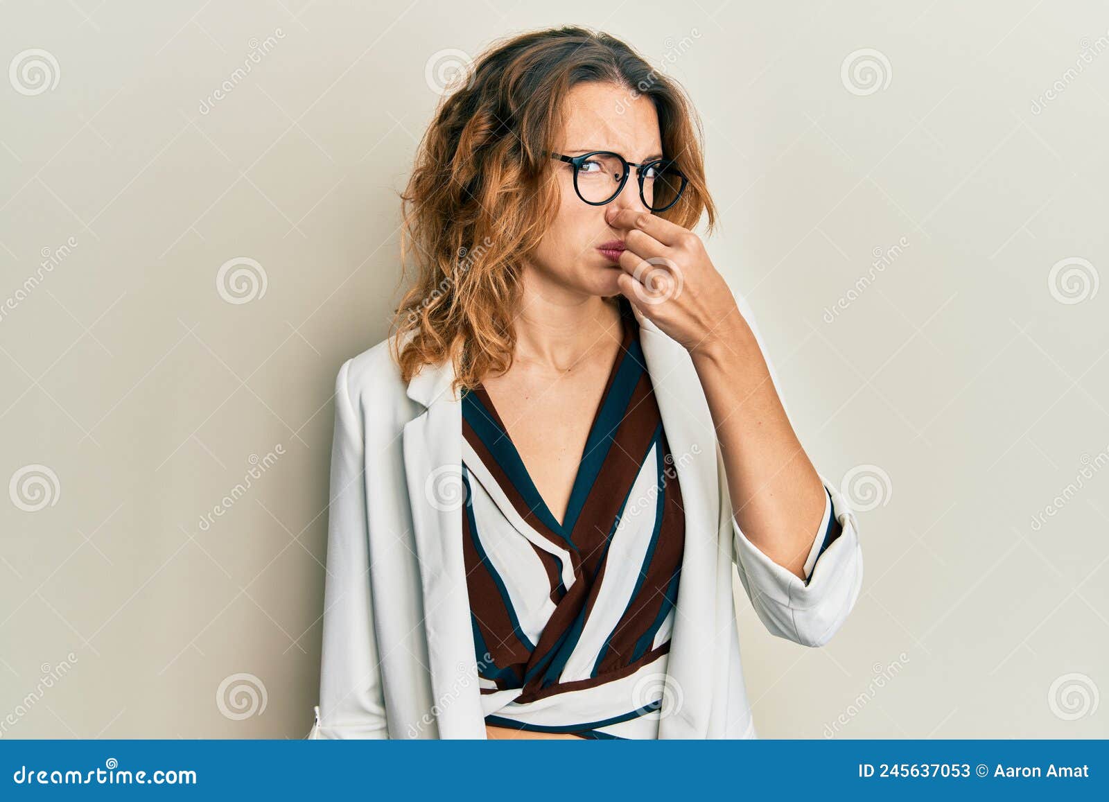 Young Caucasian Woman Wearing Business Style And Glasses Smelling