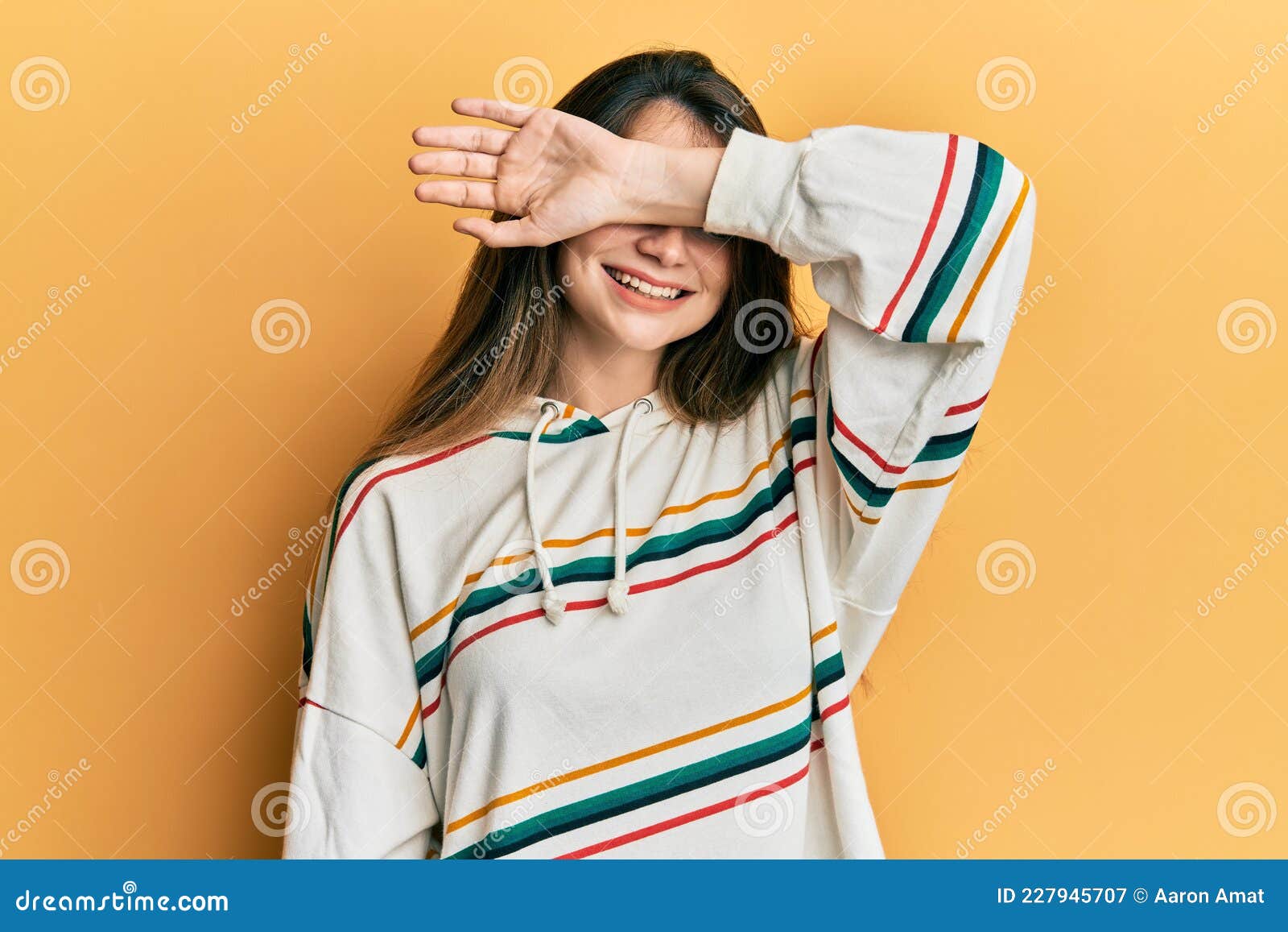 Young Caucasian Woman Wearing Casual Clothes Covering Eyes With Arm
