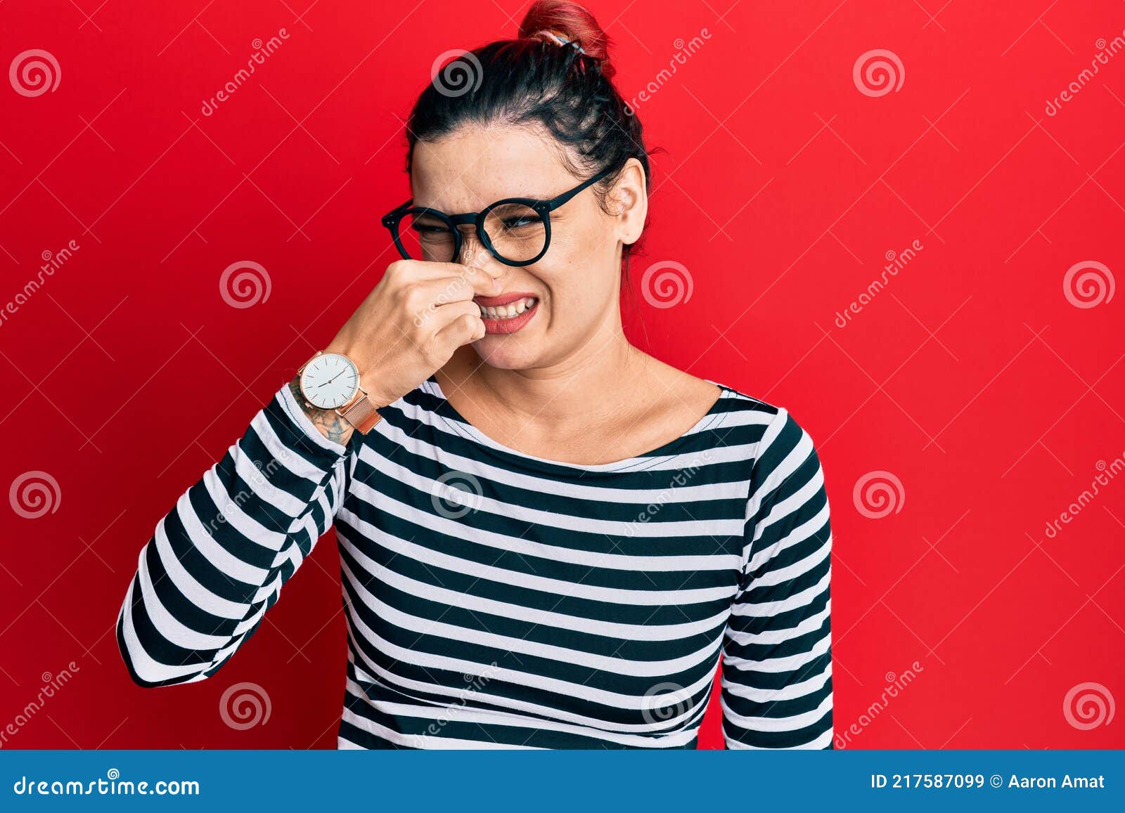 Young Caucasian Woman Wearing Casual Clothes And Glasses Smelling