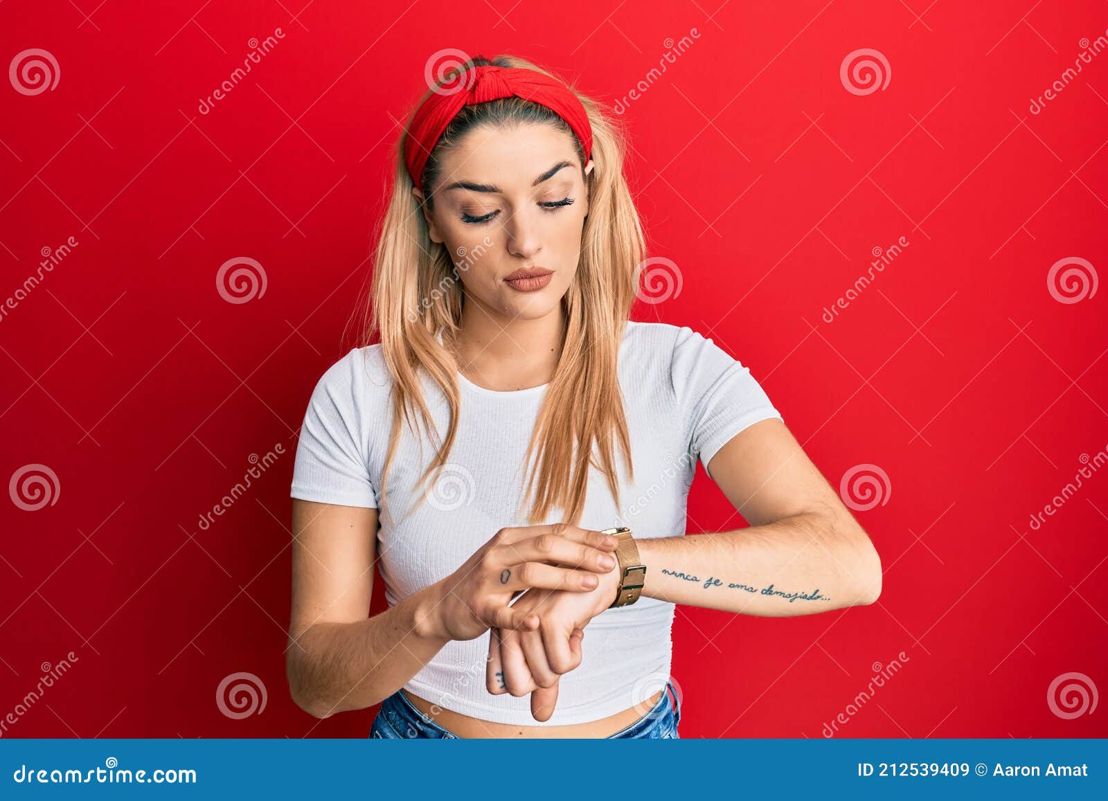 Young Caucasian Woman Wearing Casual White T Shirt Checking The Time On