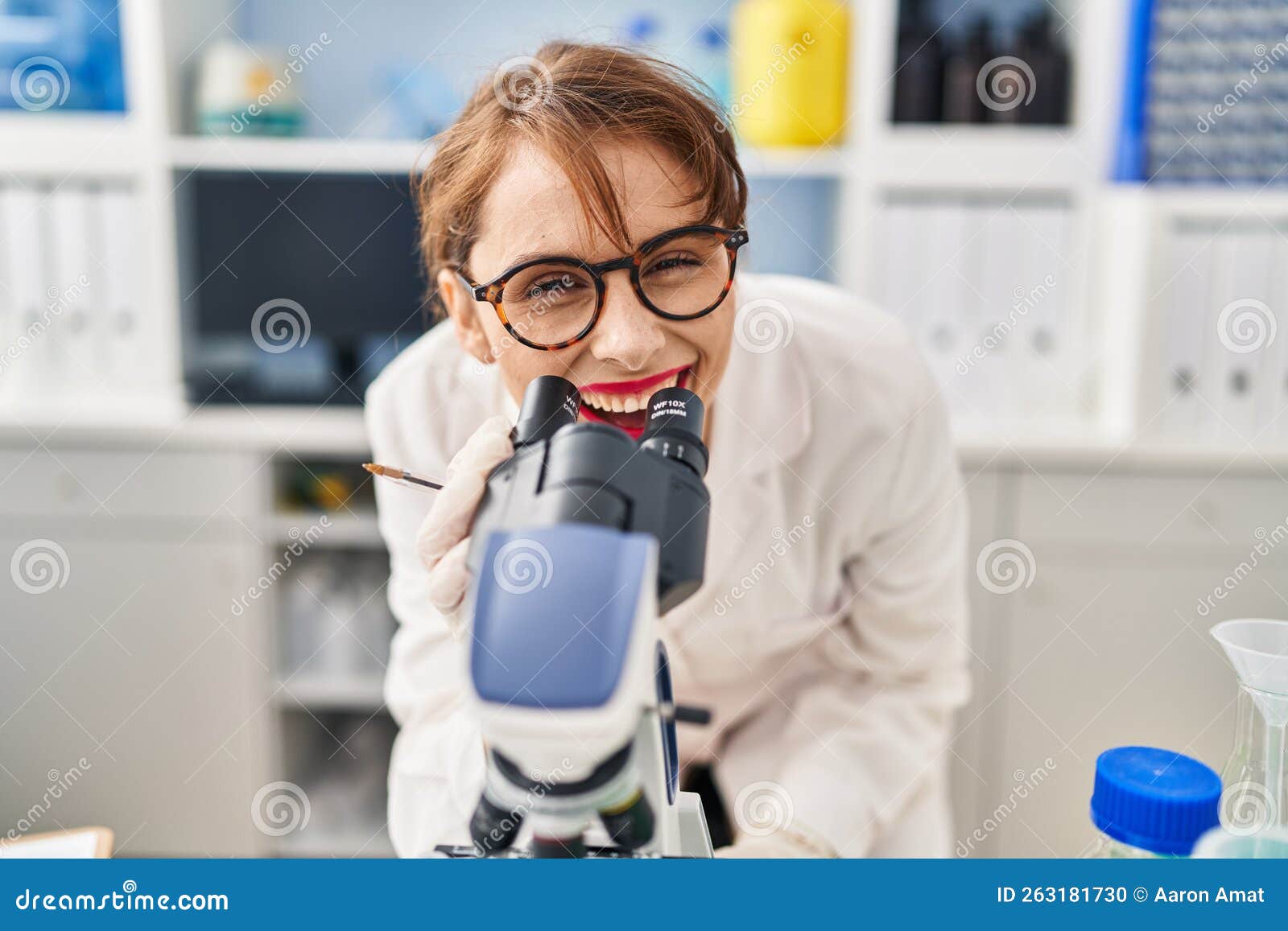 Young Caucasian Woman Wearing Scientist Uniform Using Microscope at ...