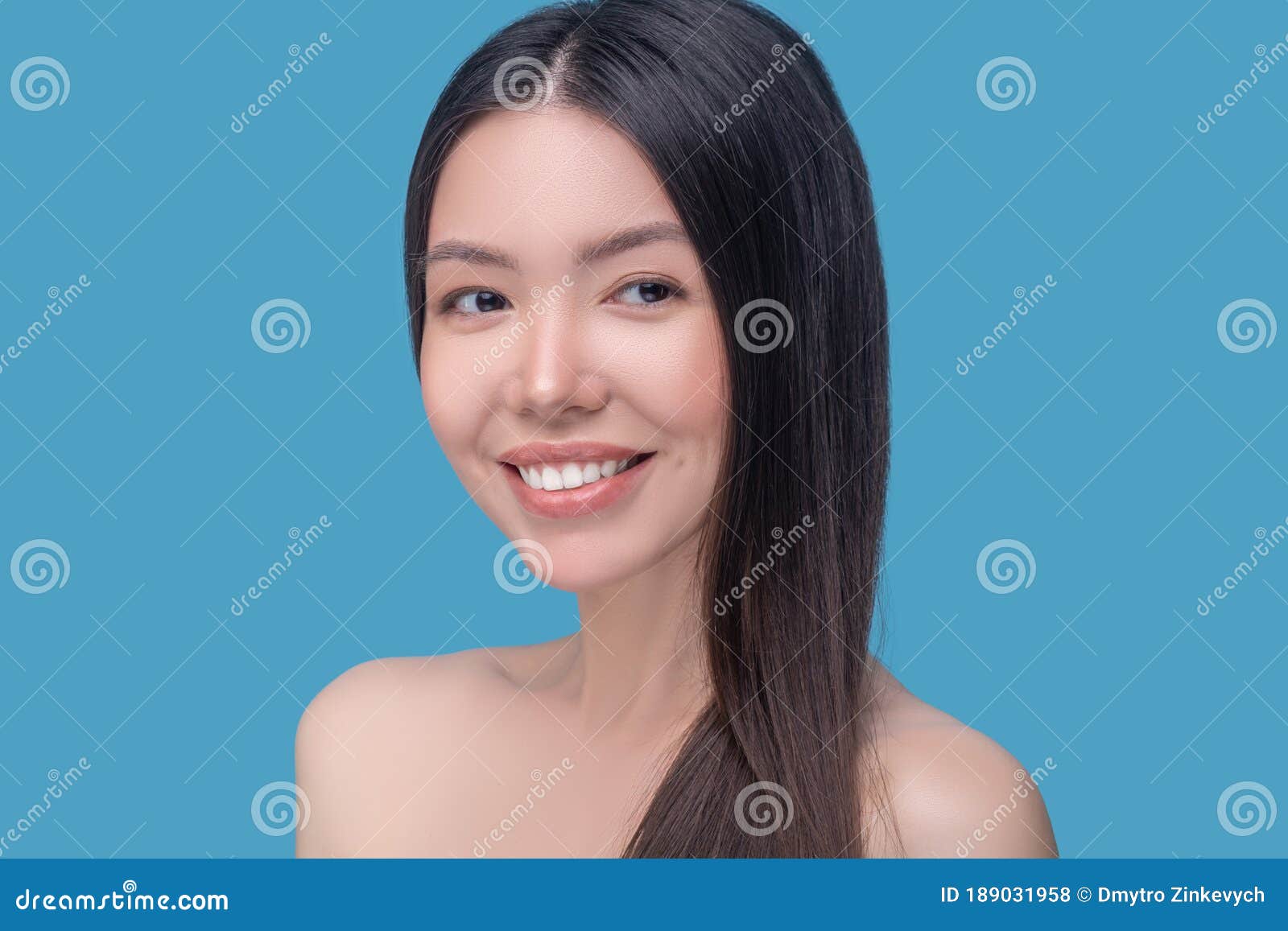Smiling Long-haired Woman on a Blue Background Stock Photo - Image of ...