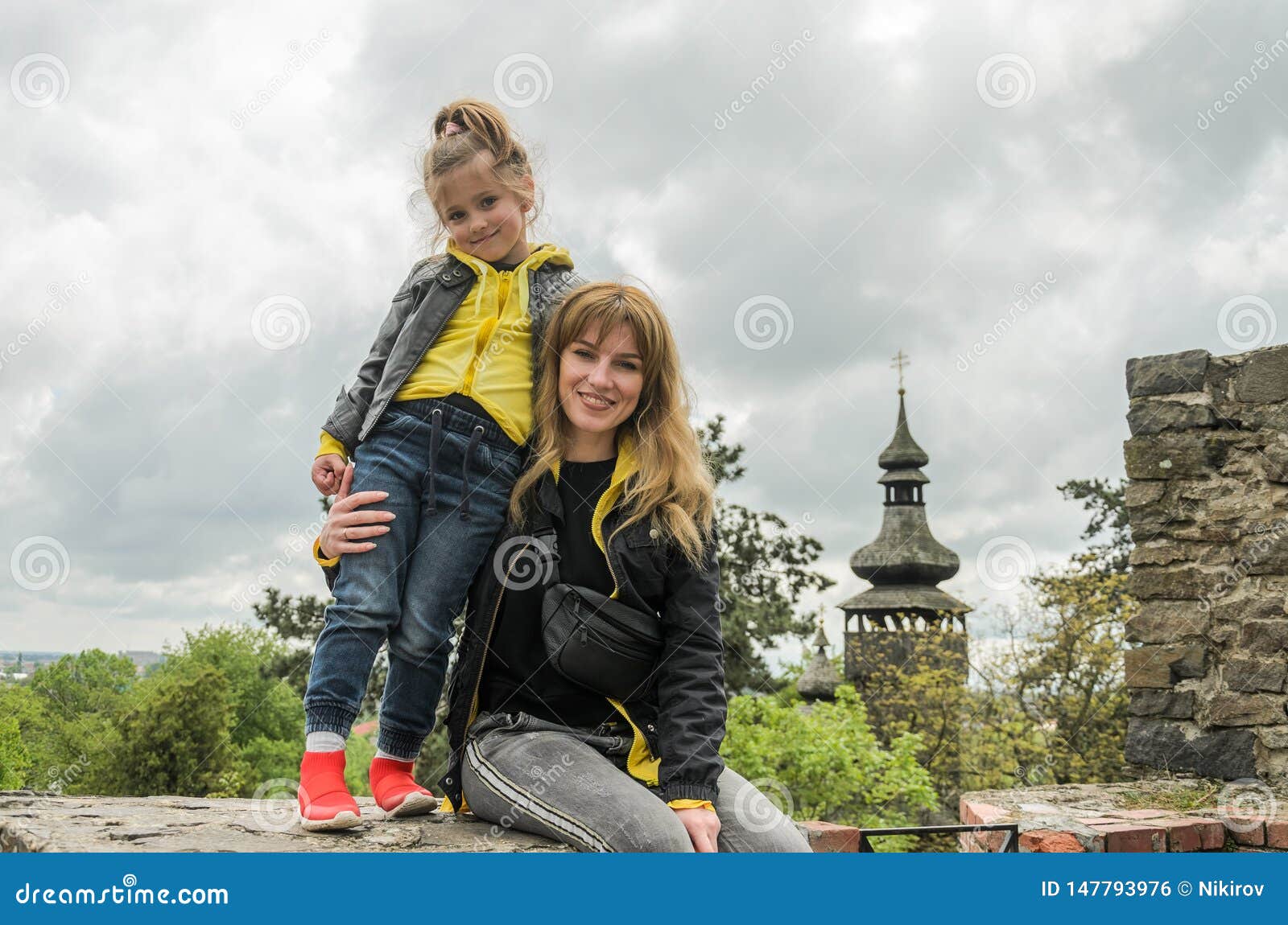 Young Charming Mother and Daughter on the Ruins of an Old Fortress ... Young Charming Mother and Daughter on the Ruins of an Old Fortress ...