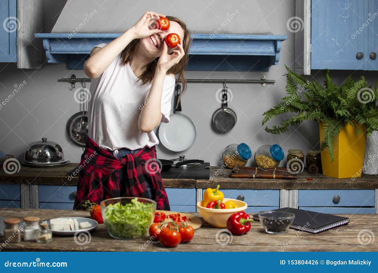 Young Girl Prepares A Vegetarian Salad In The Kitchen The Process Of