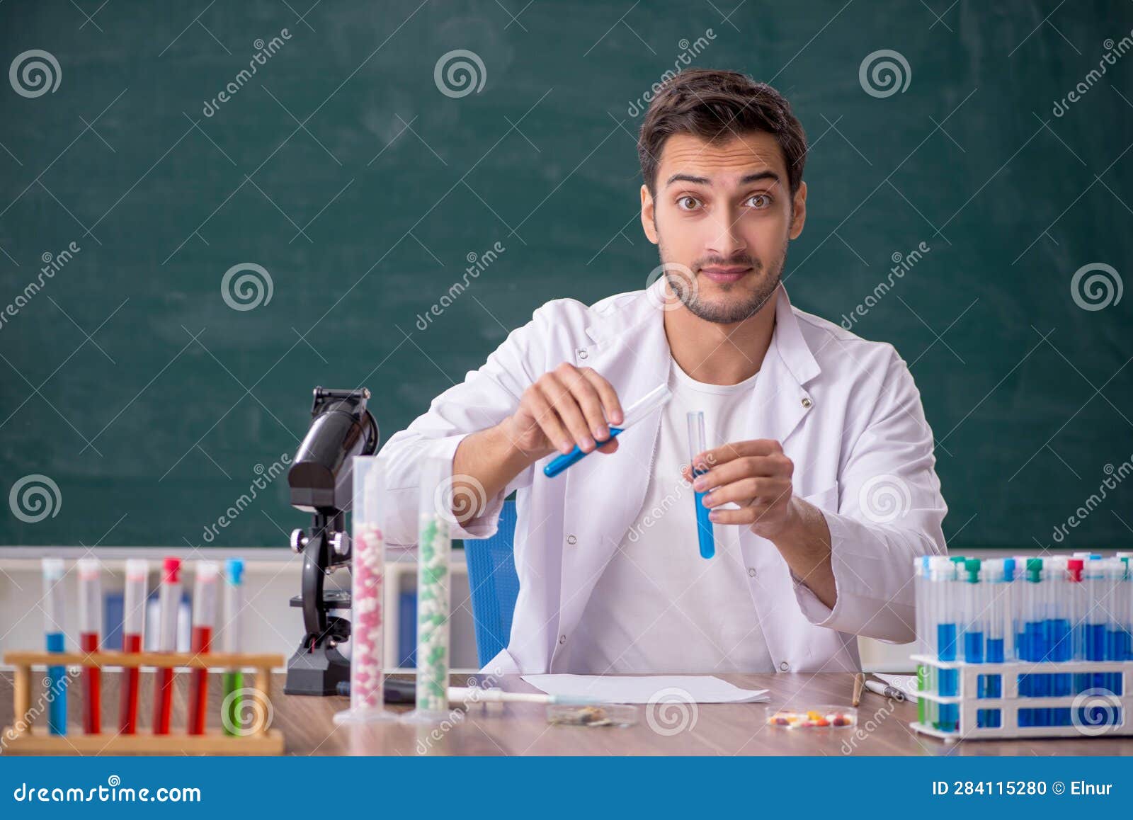 Young Male Chemist in Front of Green Board Stock Photo - Image of study ...