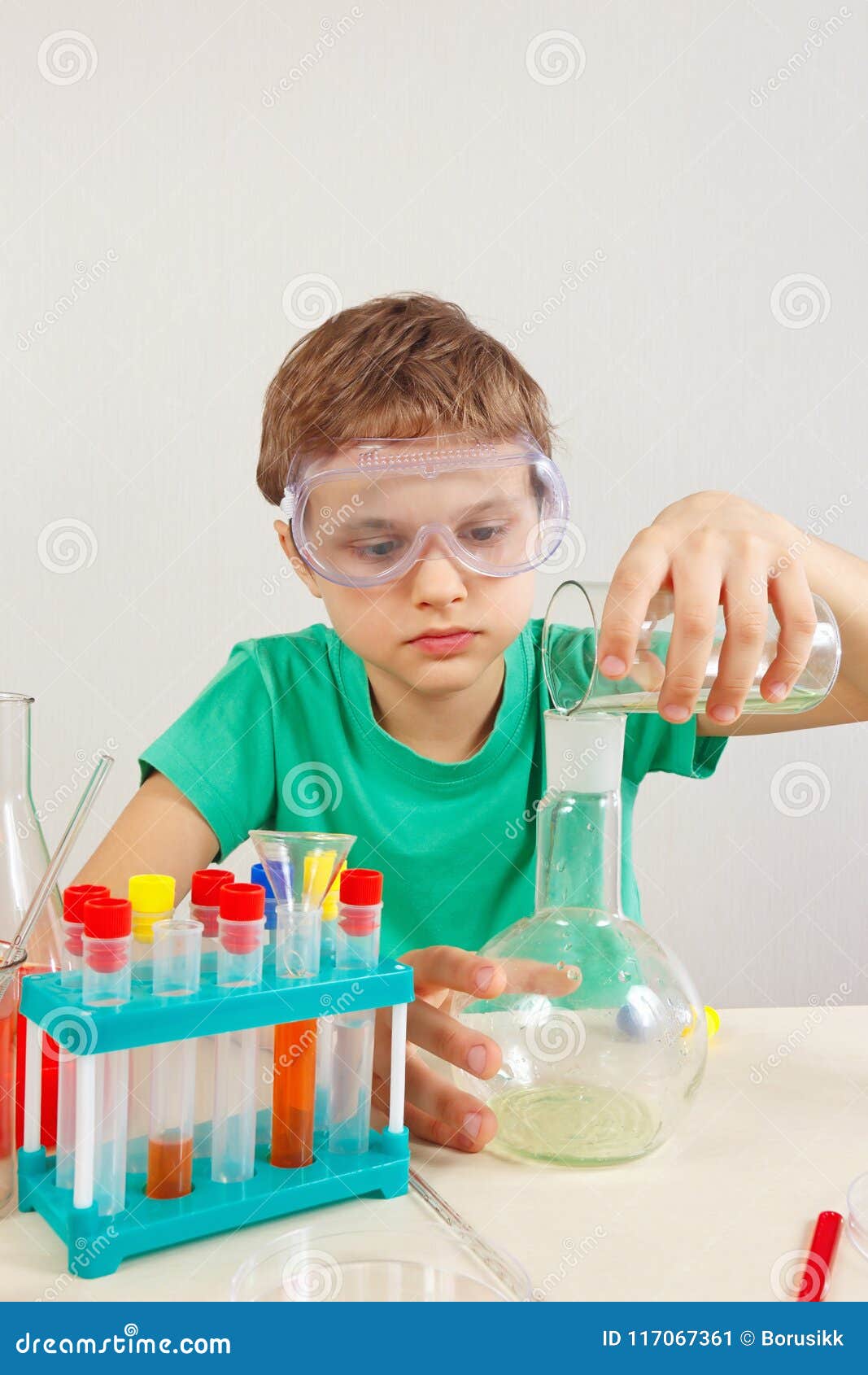 Young Chemist In Safety Goggles Doing Chemical Experiments In ...