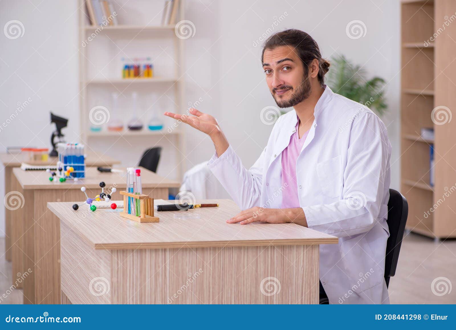 Young Male Chemist Sitting at the Desk in the Classroom Stock Photo ...