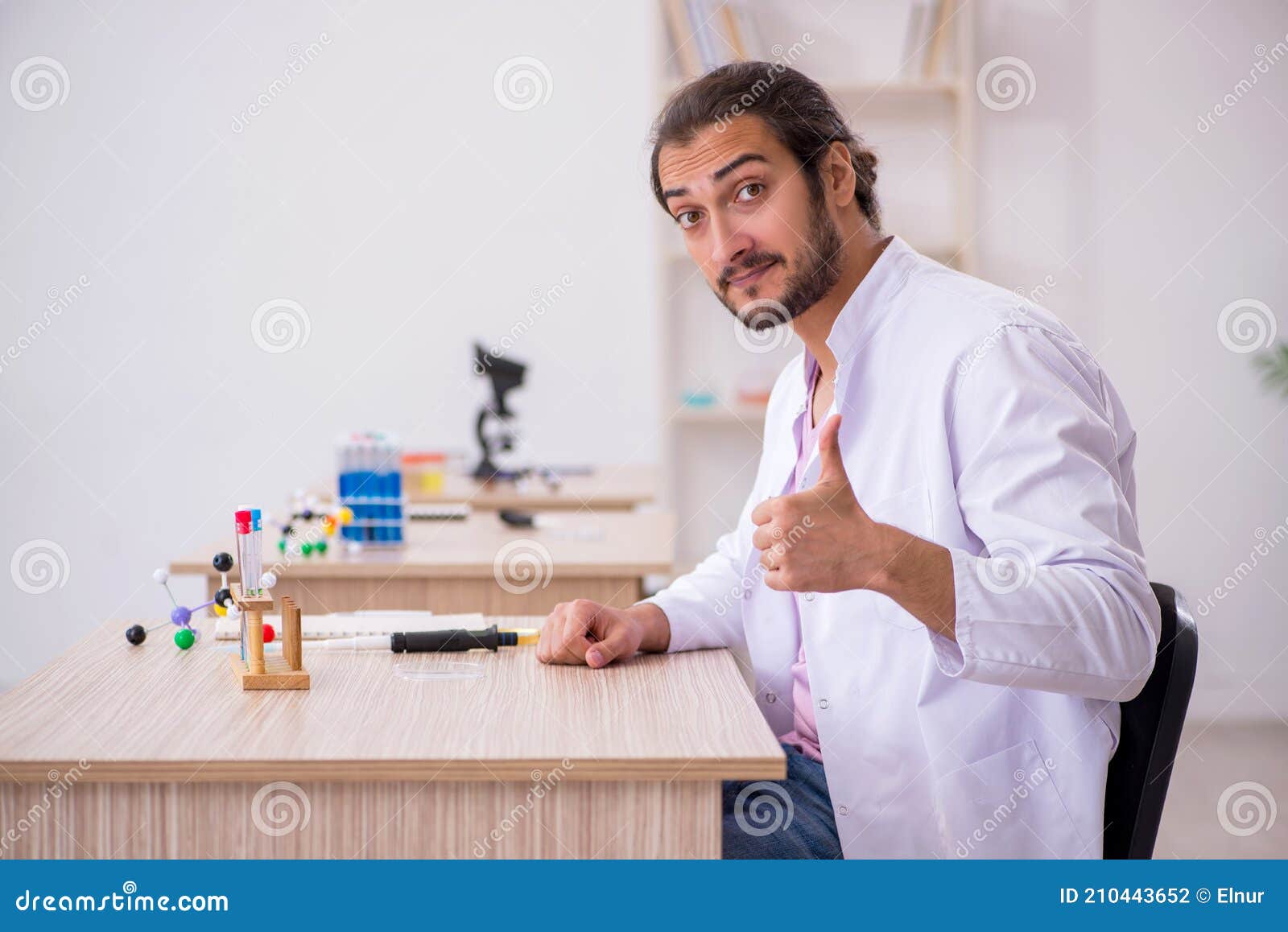 Young Male Chemist Sitting at the Desk in the Classroom Stock Photo ...
