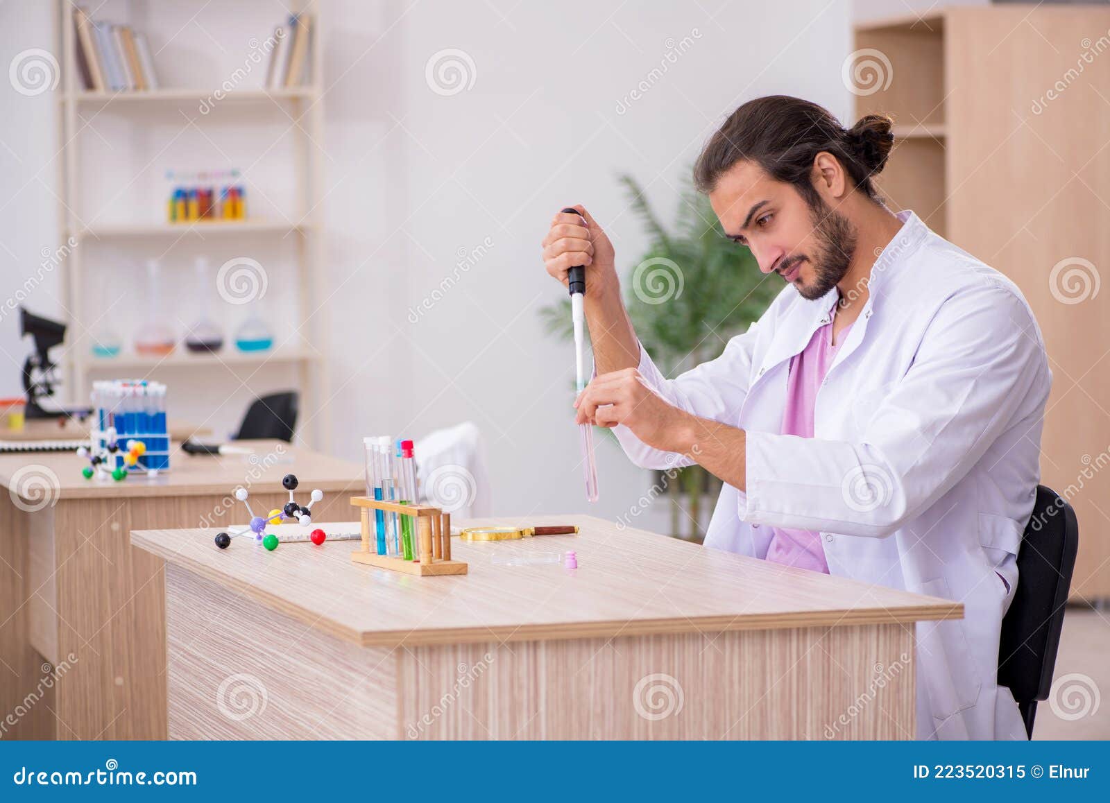 Young Male Chemist Sitting at the Desk in the Classroom Stock Image ...