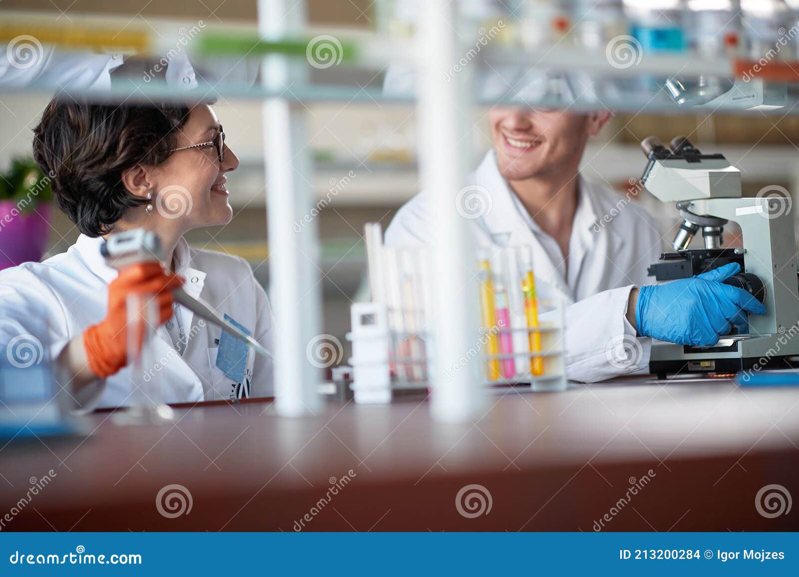 Young Chemistry Students are Chatting while Pipetting and Microscoping ...