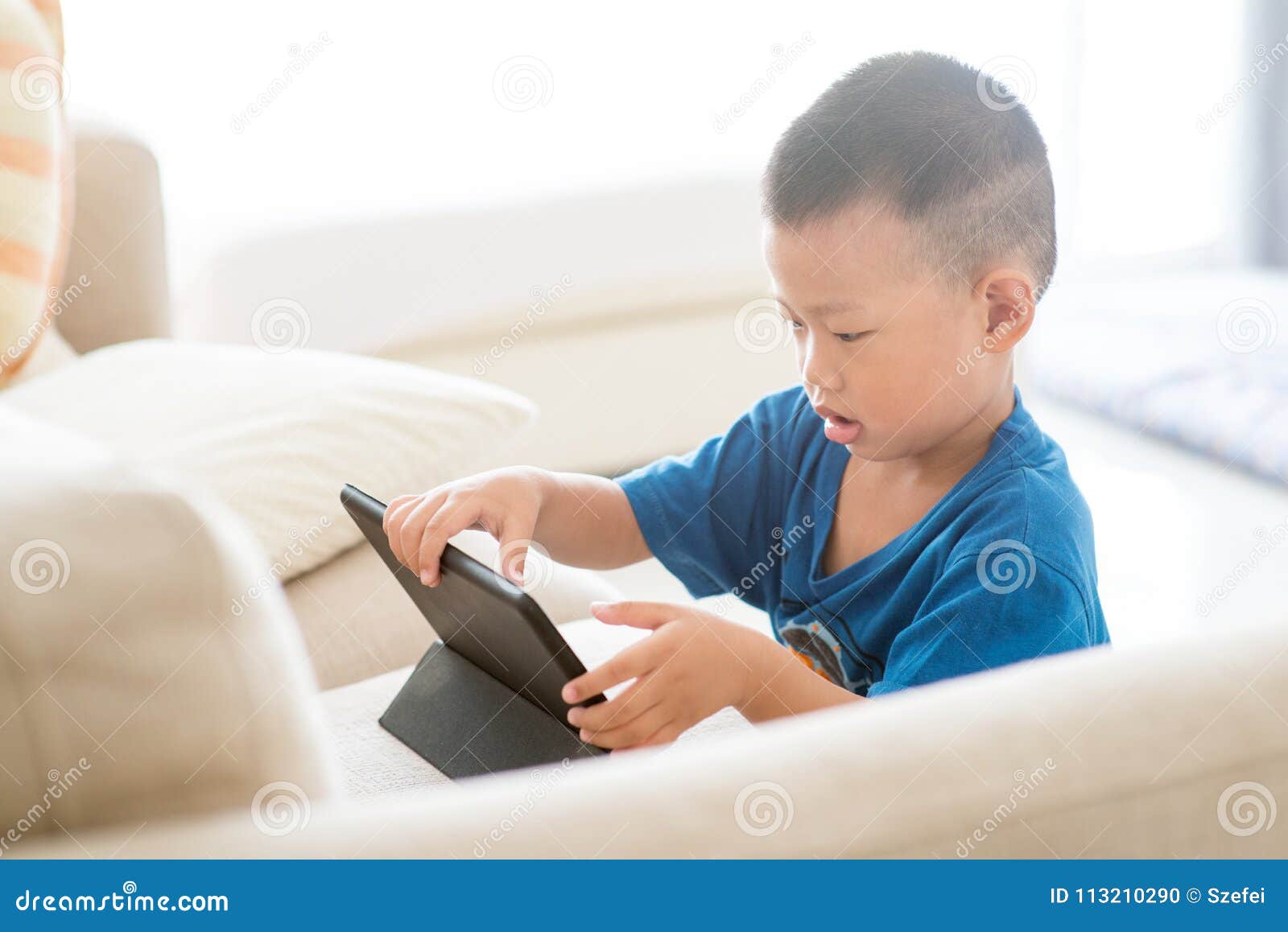 Young Child Addicted To Tablet. Stock Photo - Image of family ...