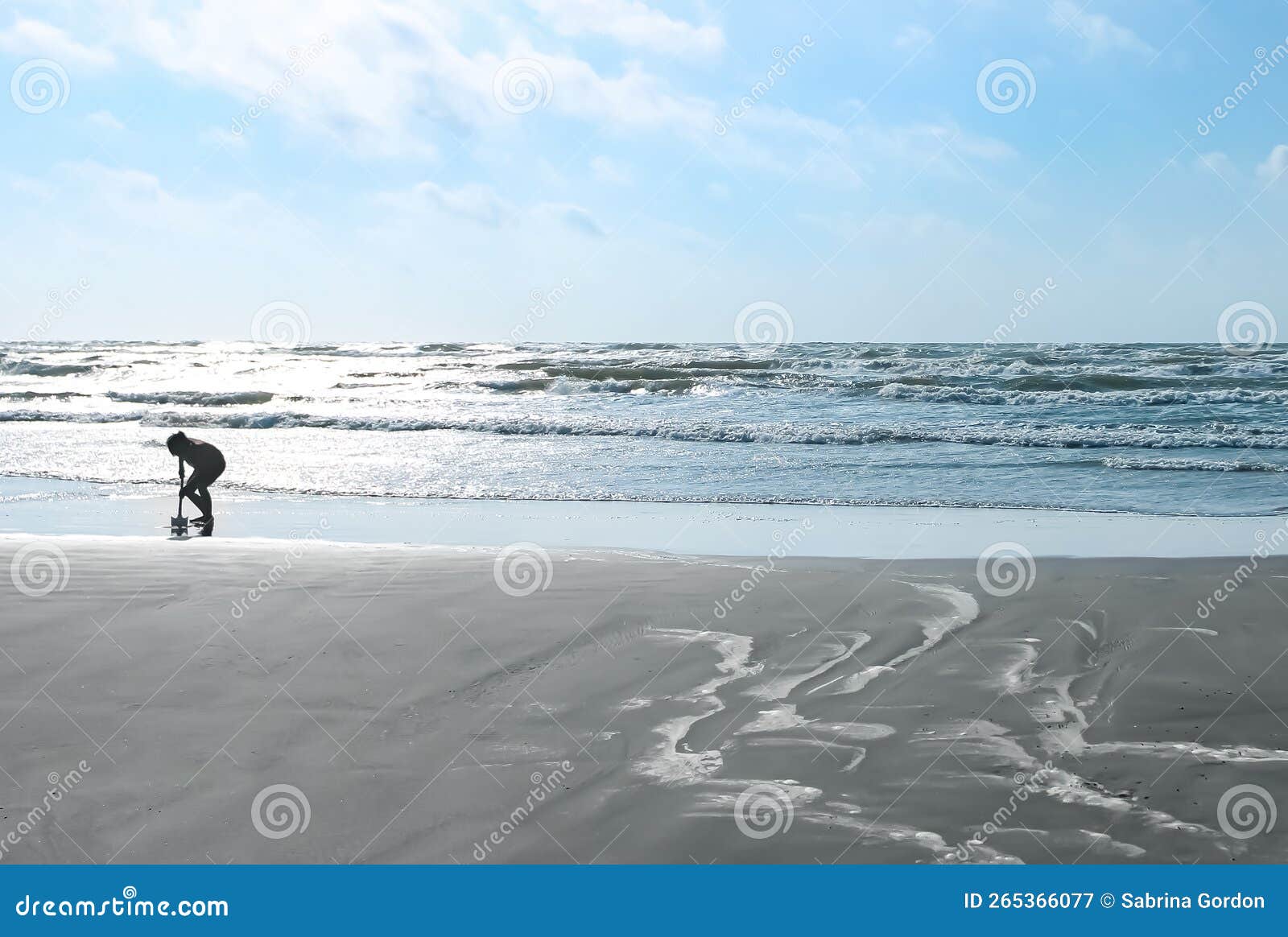 Digging on the Beach stock image. Image of child, sunlight - 265366077