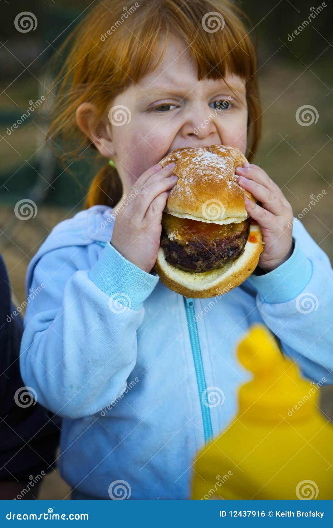 Young Child Eating Hamburger Stock Photo - Image of pensive, lunch ...