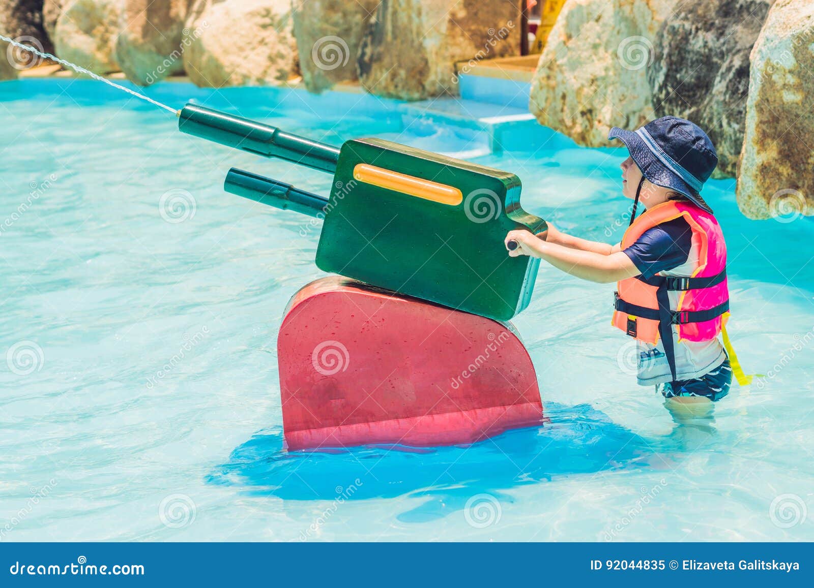 Young Child Having Fun with Water Cannon in Aqua Park Stock Image ...