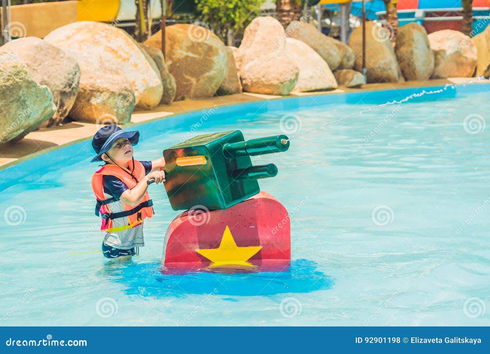 Young Child Having Fun with Water Cannon in Aqua Park Stock Photo ...