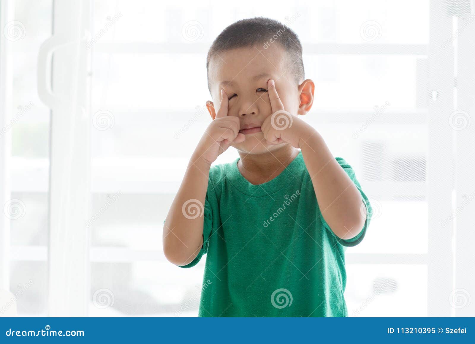 Playful boy pulling face stock image. Image of asian - 113210395