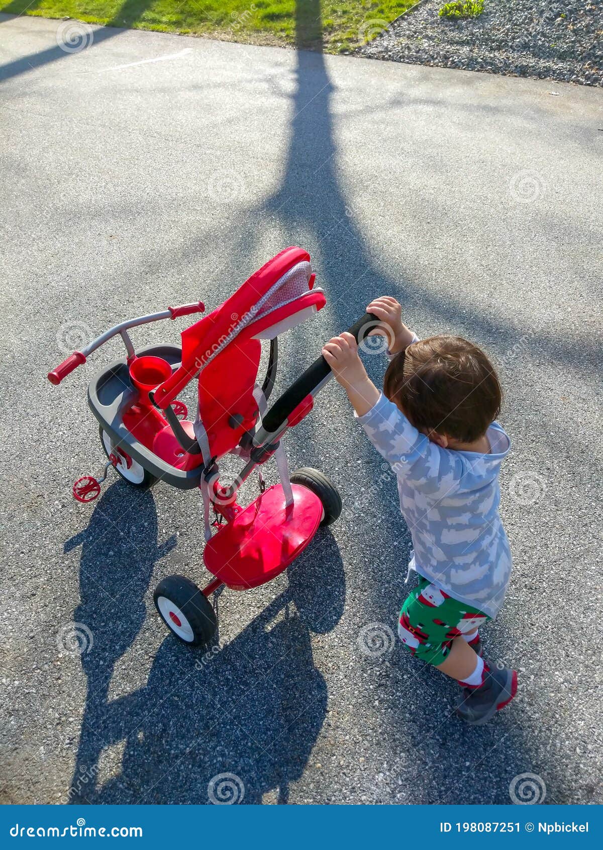 Child Pushing A Toddler In A Stroller Royalty-Free Stock Photography ...