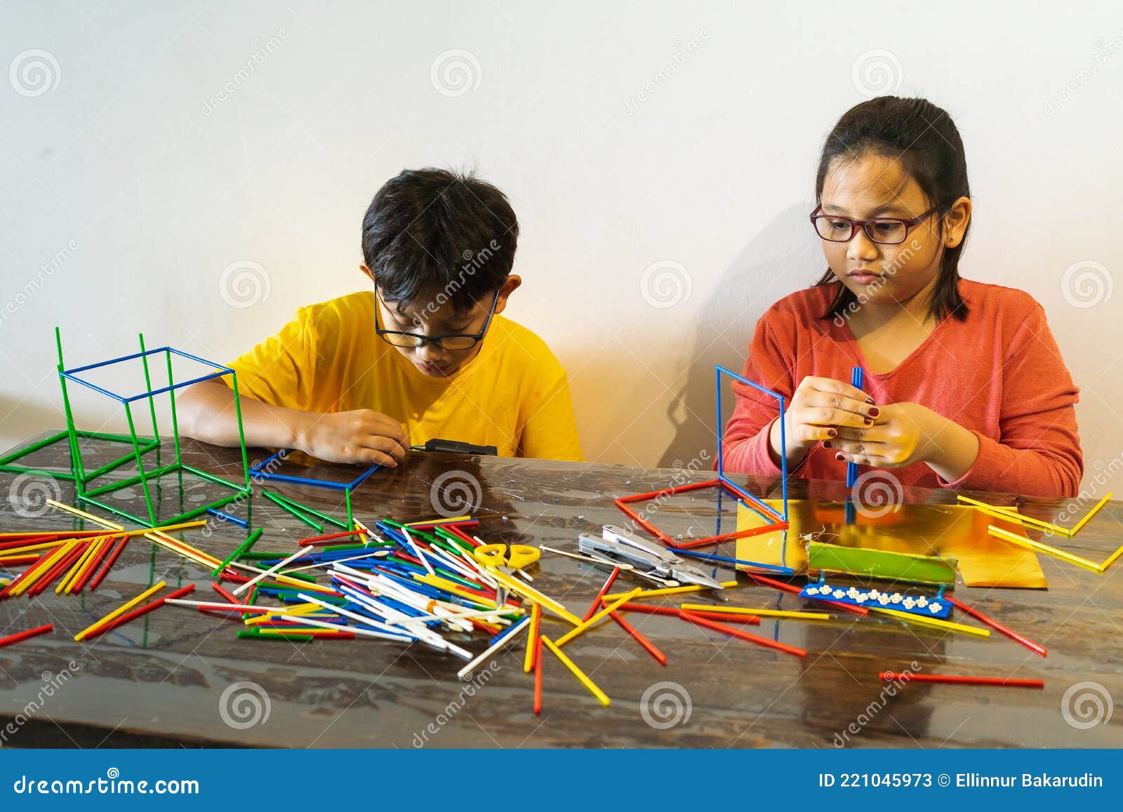 Young Children are Constructing Colorful Plastic Sticks with Glue Gun ...