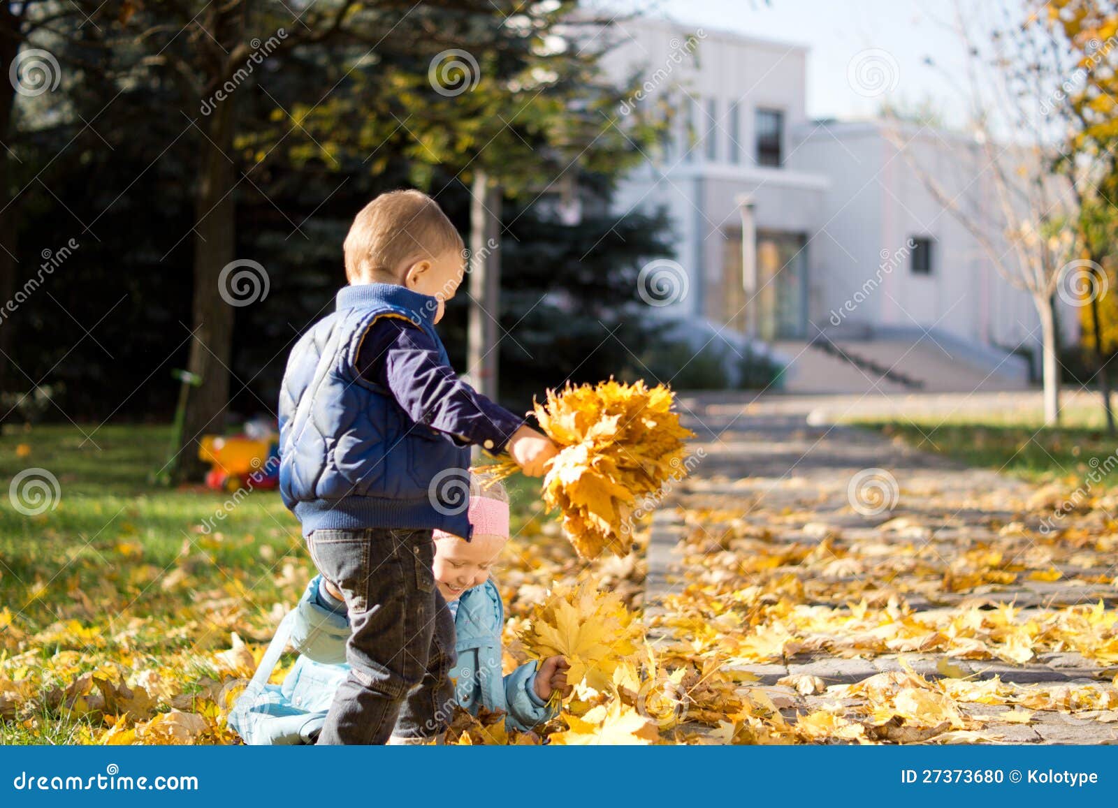 Young Children Gathering in Leaves in Autumn Park Stock Photo - Image ...