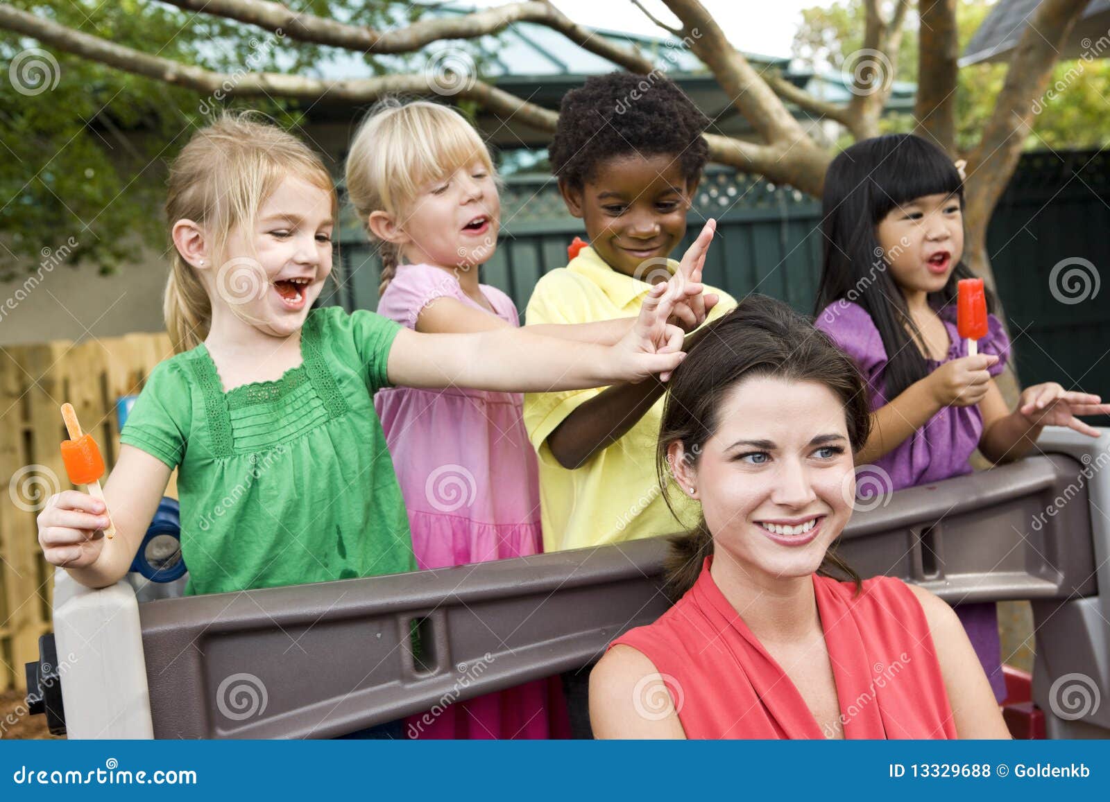 Young Children Playing in Daycare with Teacher Stock Photo - Image of ...