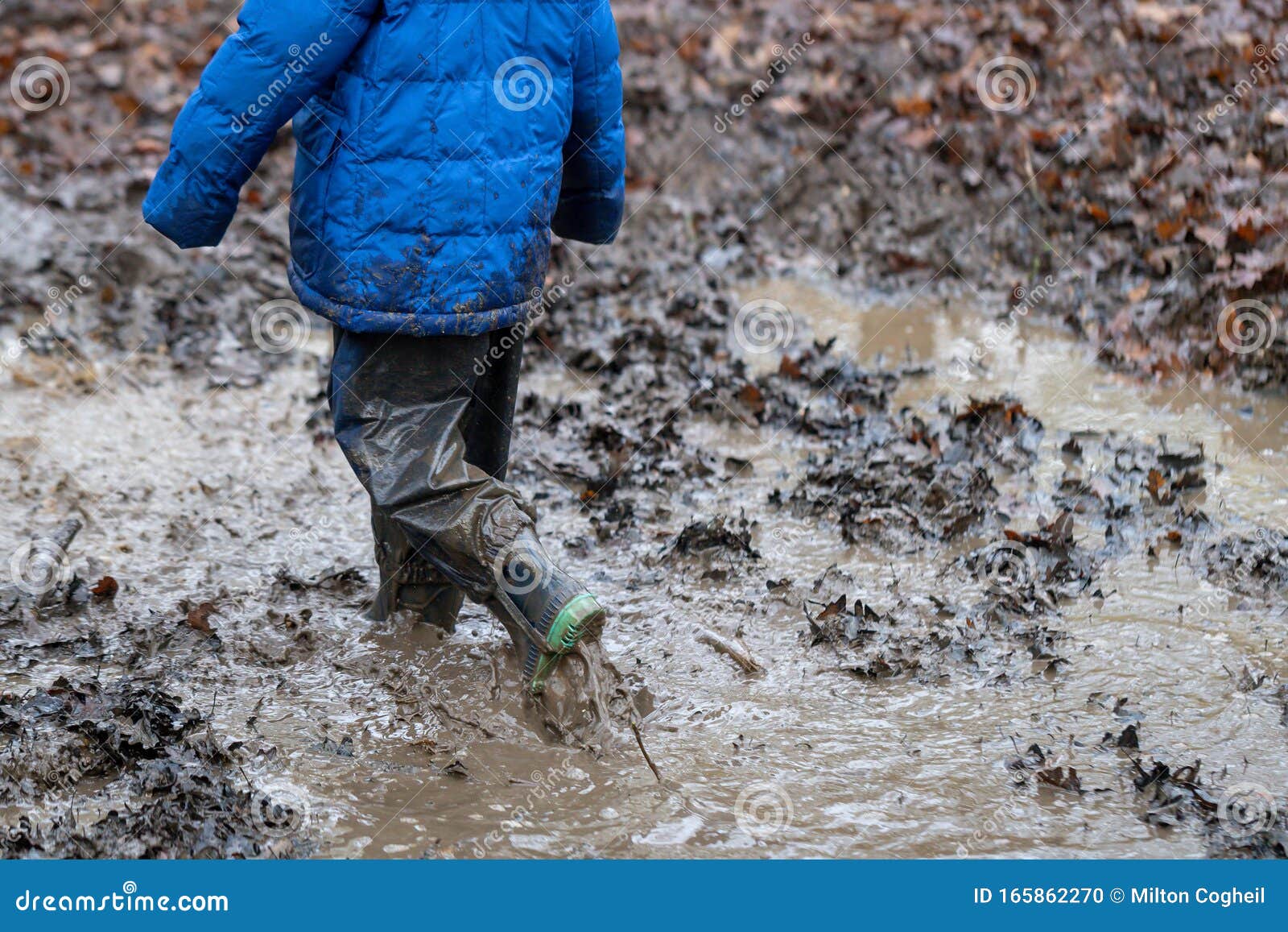 Young Children Playing in a Mud Puddle Stock Photo - Image of jump ...