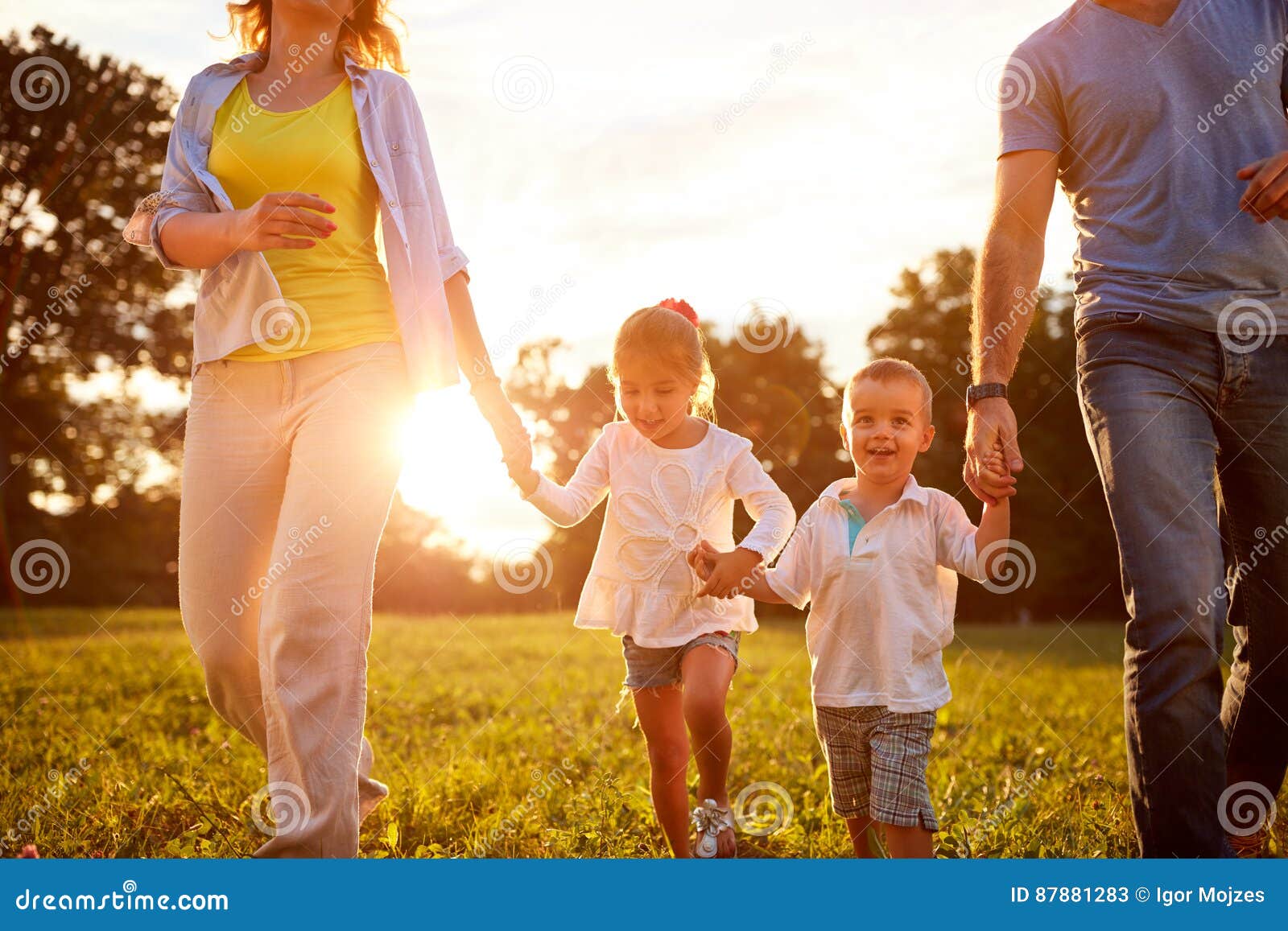 Young Children Walking with Parents in Park Stock Image - Image of ...
