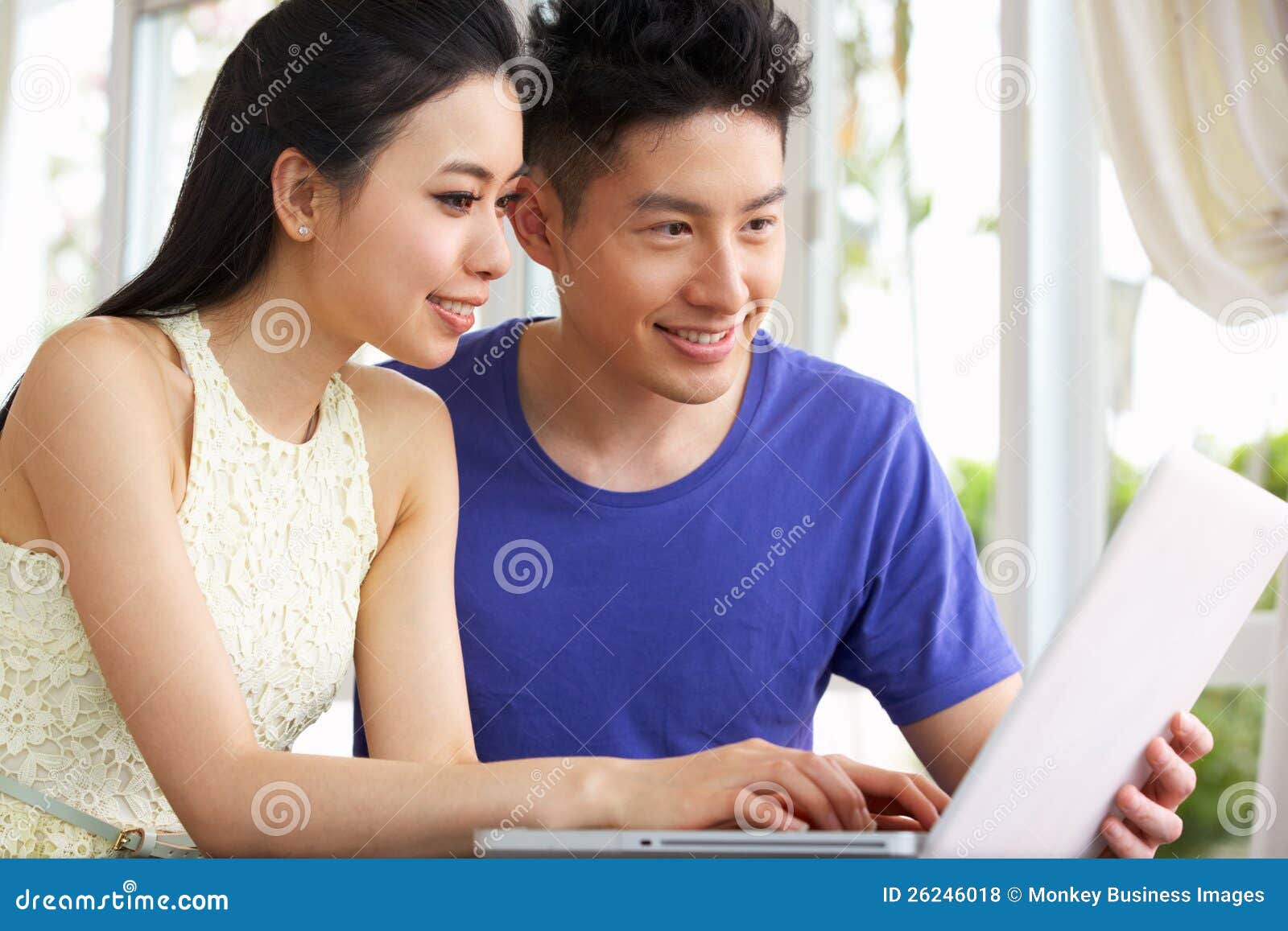 Young Chinese Couple Sitting Using Laptop at Home Stock Photo - Image ...