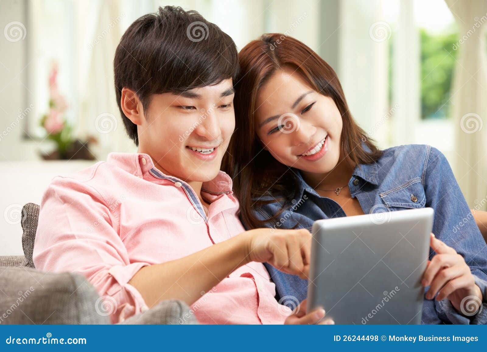 Young Chinese Couple Using Digital Tablet Stock Photo - Image of ...