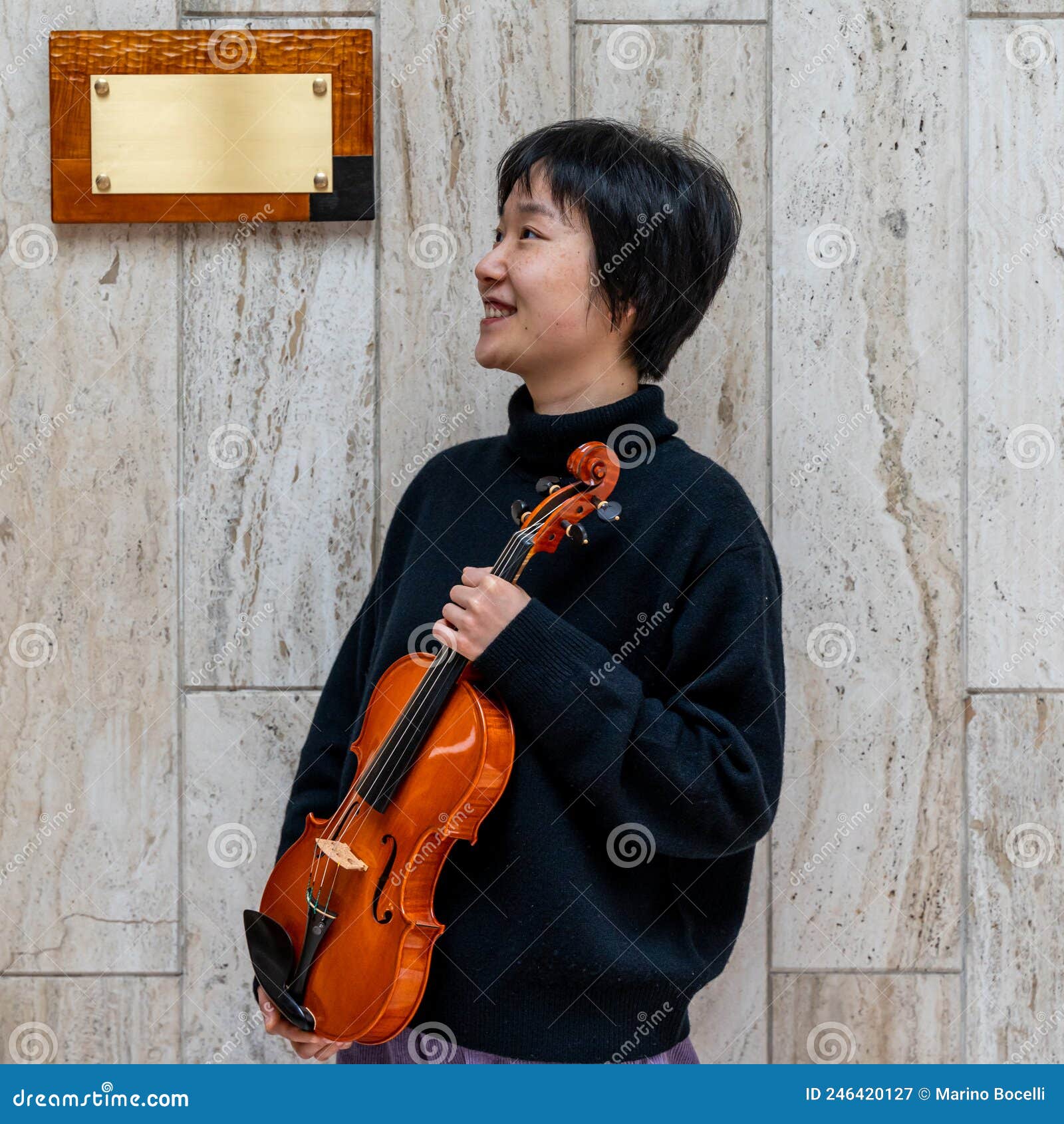 Young Chinese Female Violin Maker Showing Her Freshly Made Violin ...